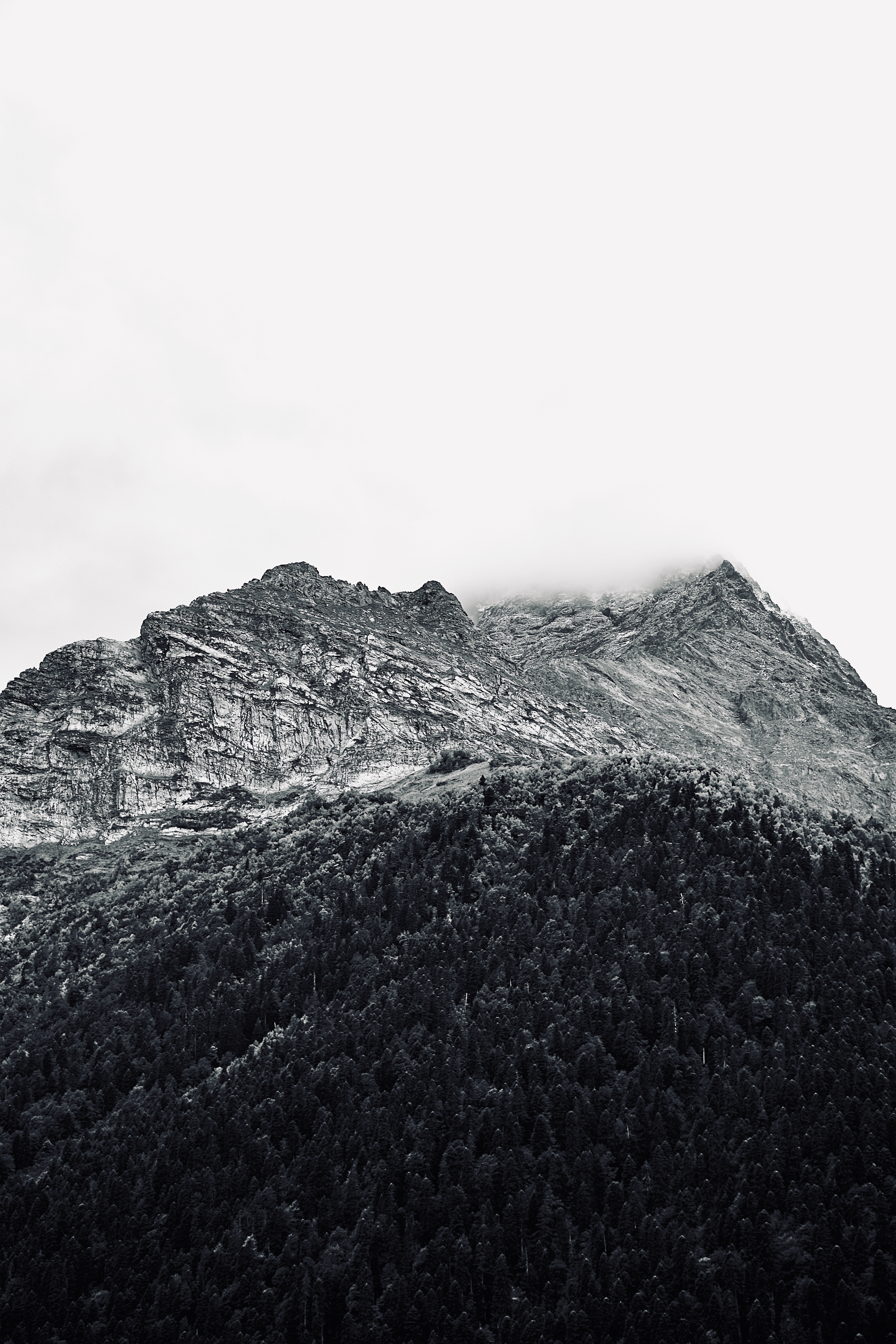 Gray and Black Rock Mountain Under White Sky · Free Stock Photo