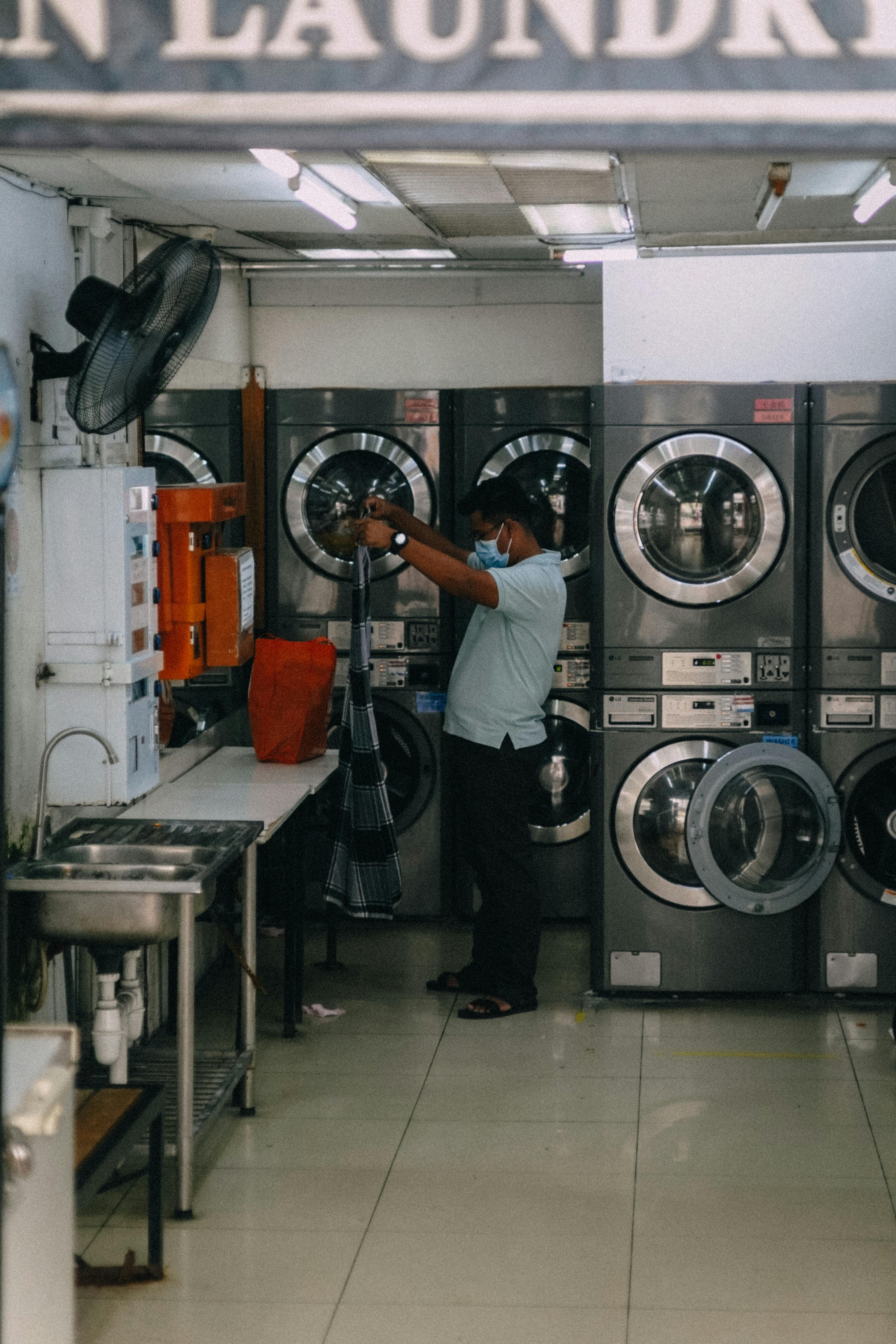 A Man in the Laundry Shop · Free Stock Photo