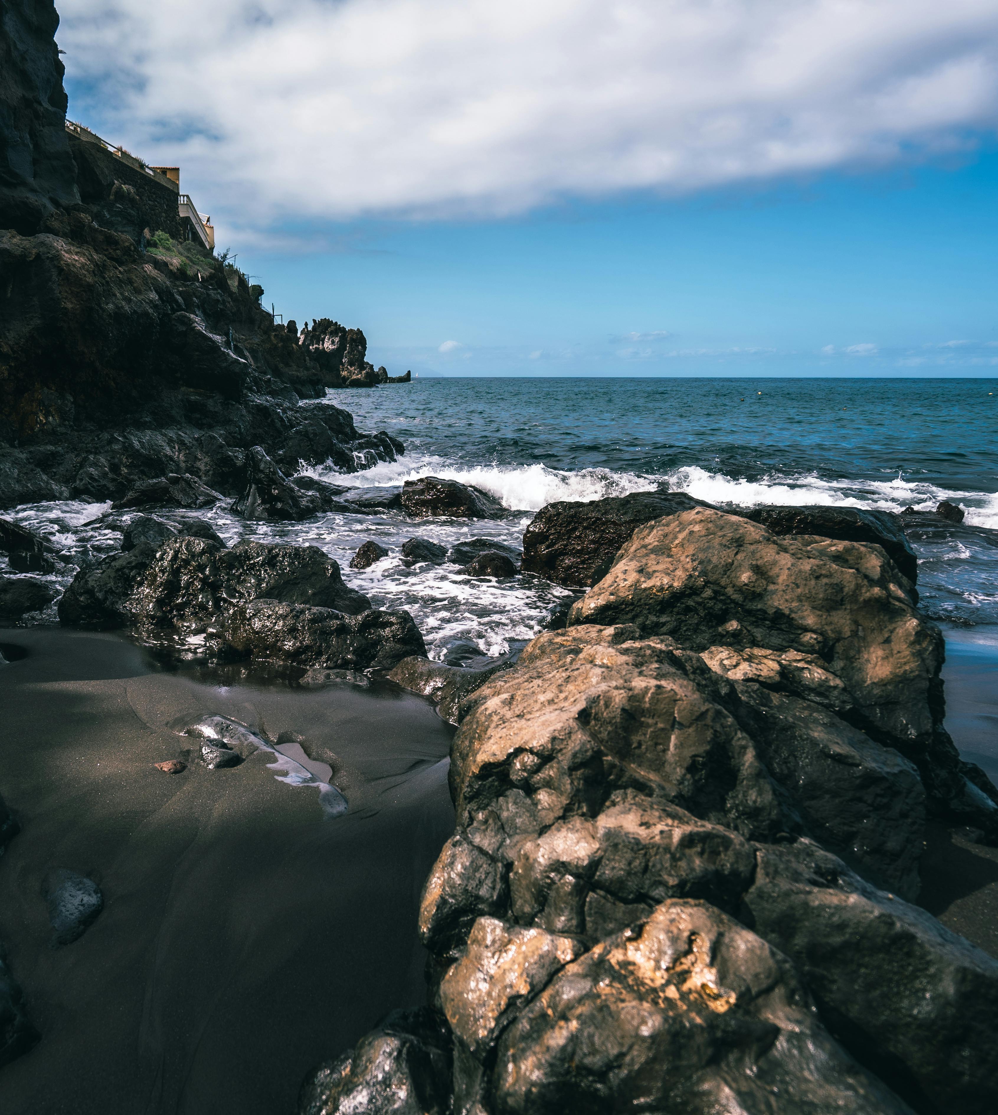 Photo of Rocks on a Shore Near the Sea · Free Stock Photo