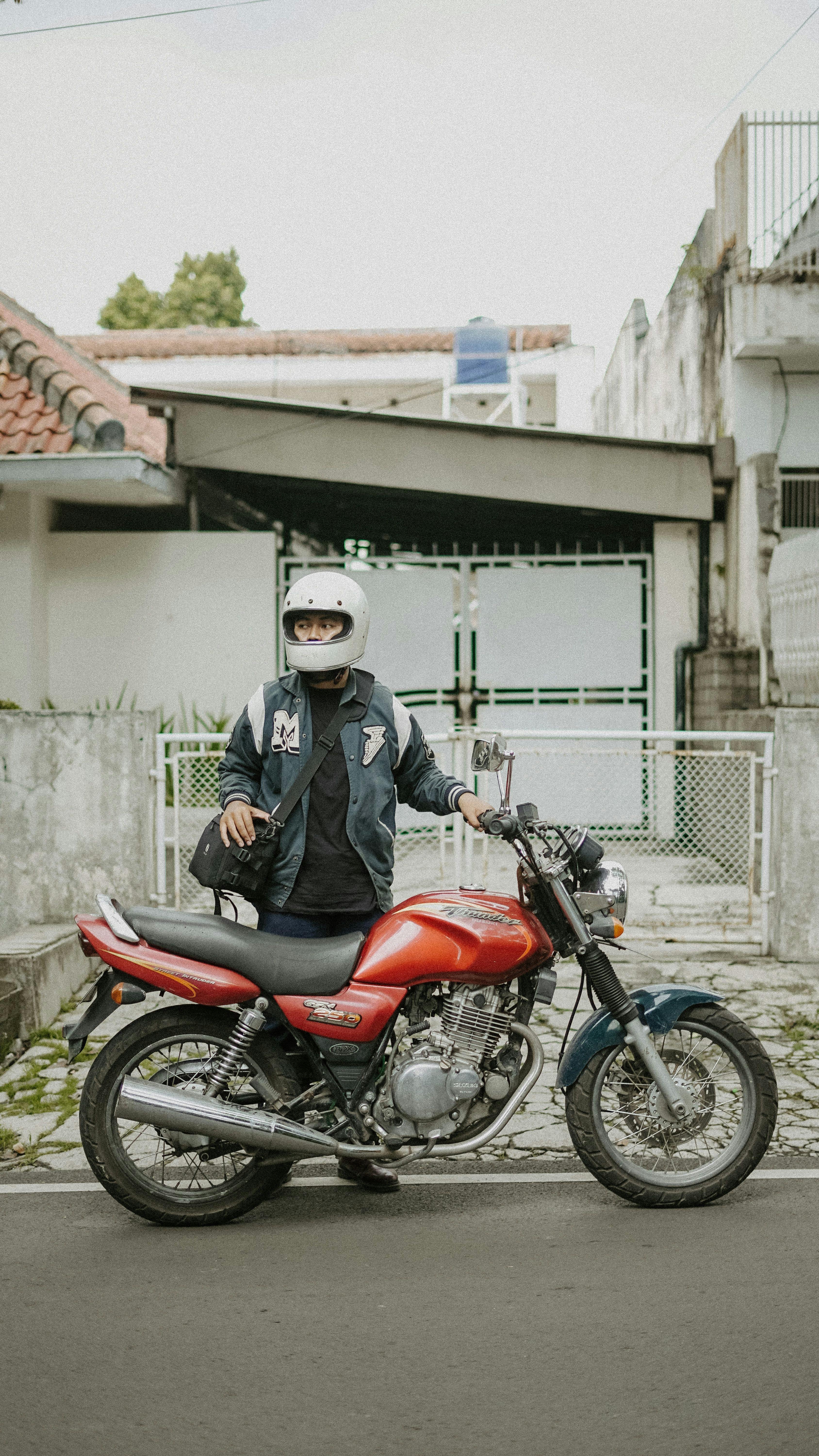 A Man Standing Beside a Motorcycle · Free Stock Photo