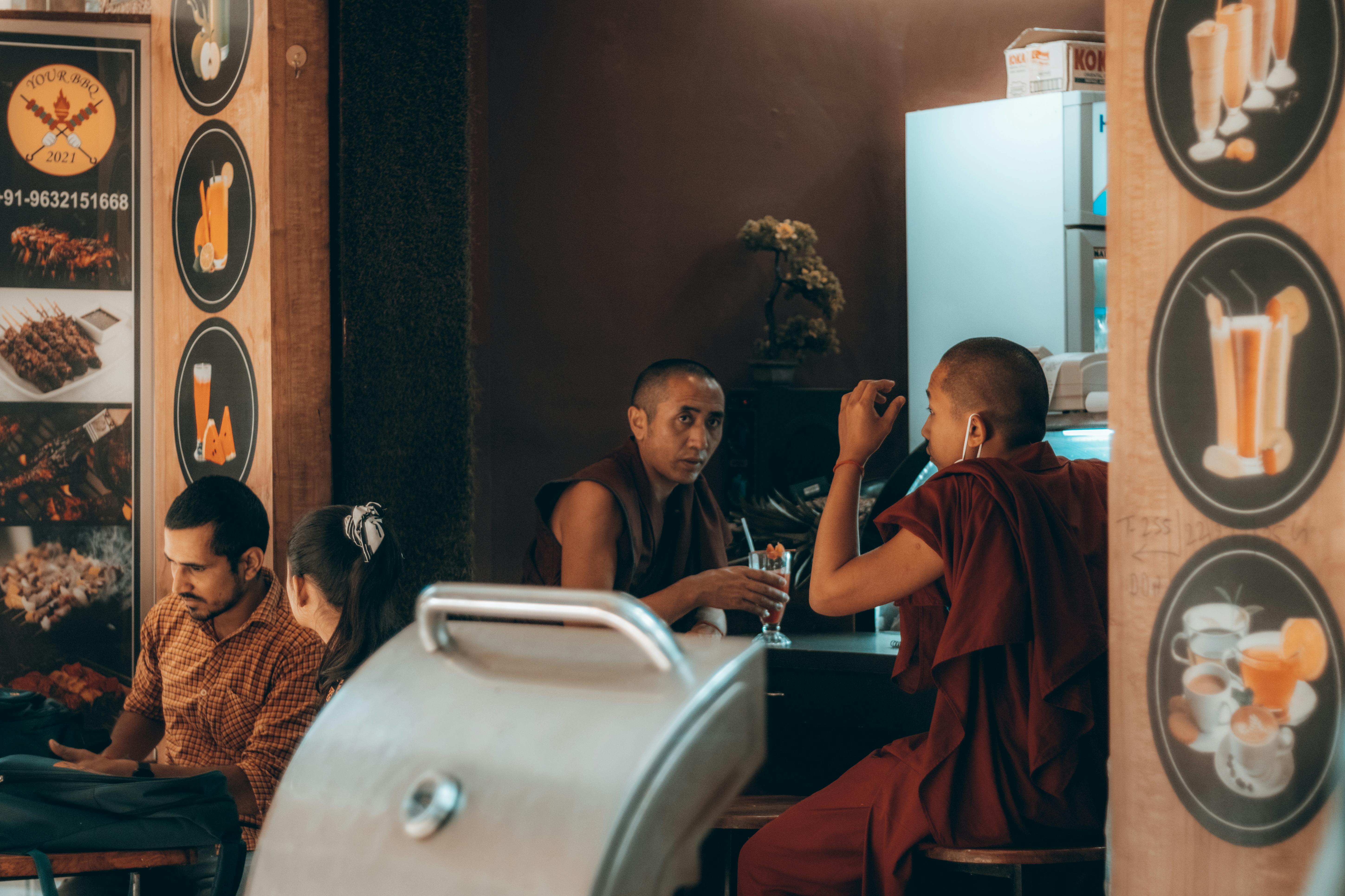 Buddhist Monks in Kasaya Sitting Inside a Restaurant · Free Stock Photo