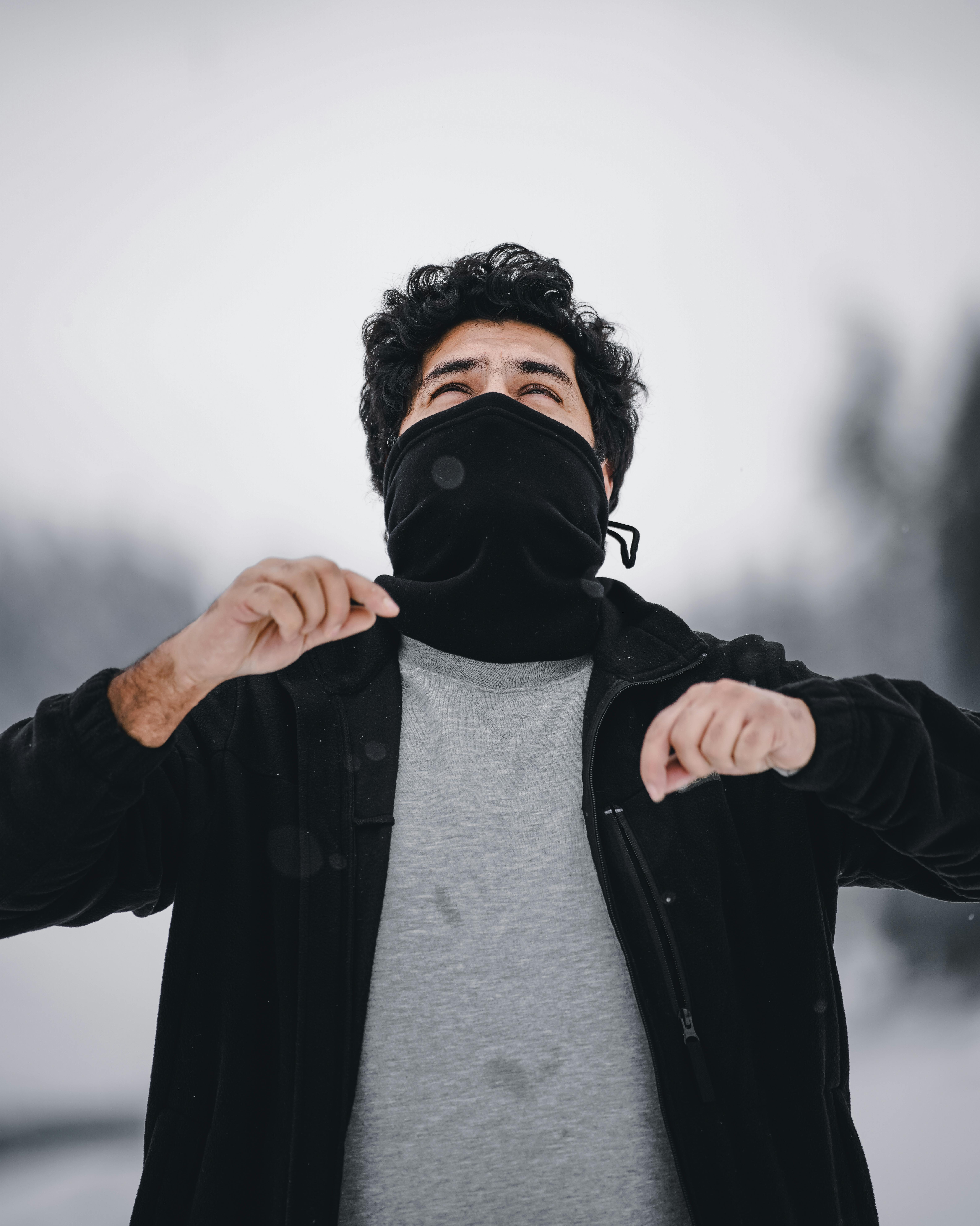 A Man in Black Jacket Covering His Face With a Snood · Free Stock Photo