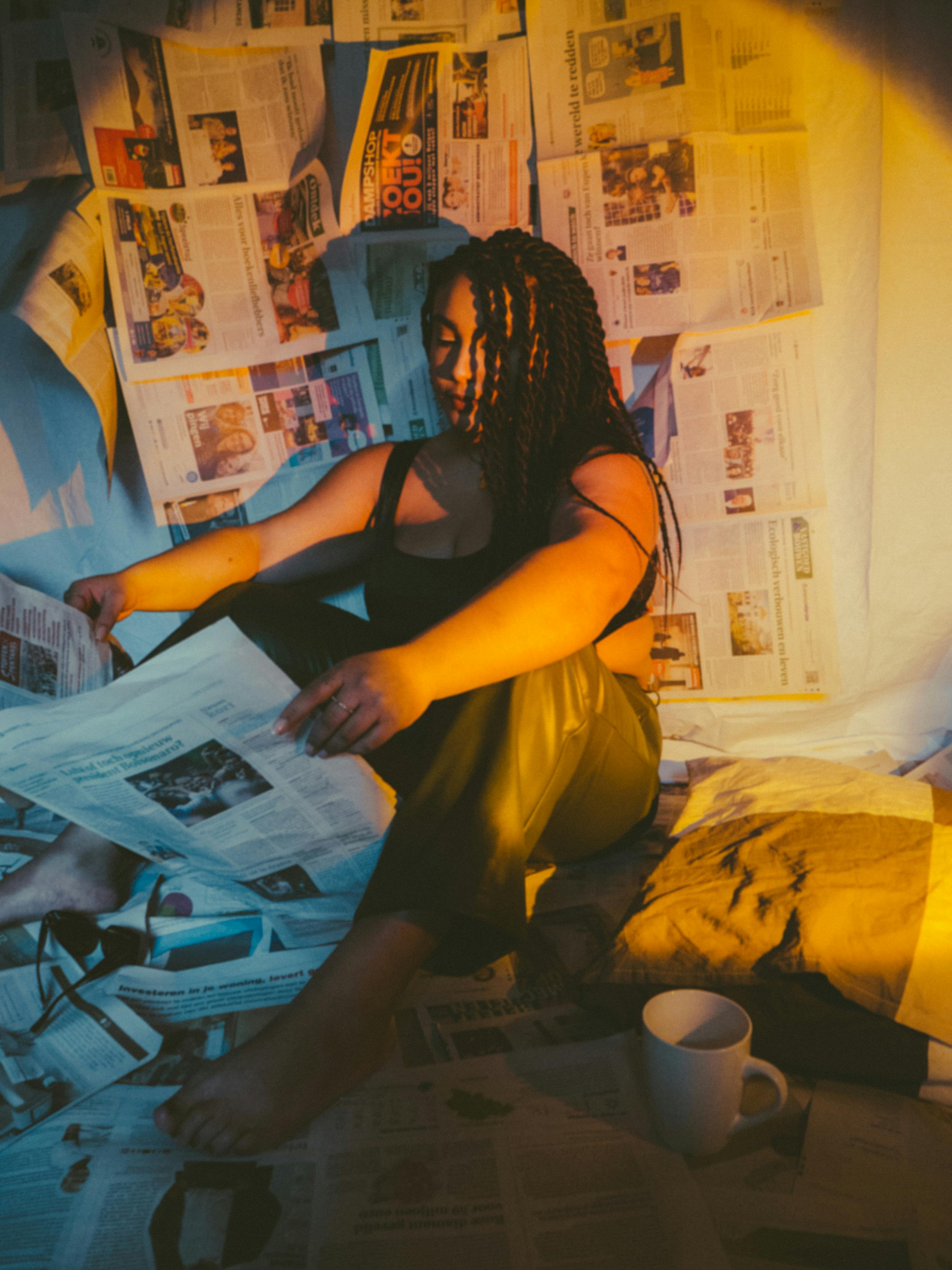 Person Reading Newspaper while Sitting on Chair · Free Stock Photo