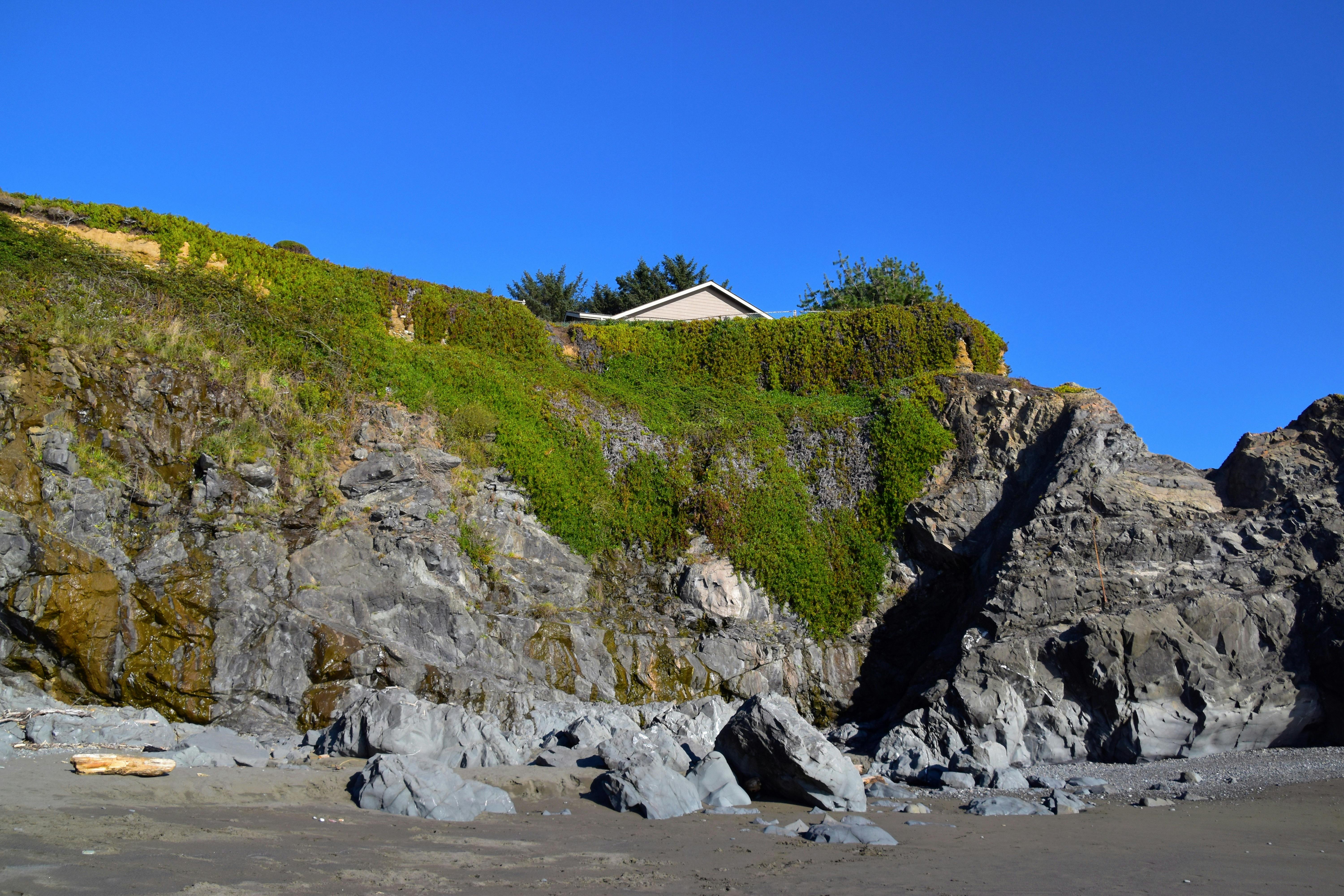Gray Rough Cliff with Grass, and Blue Sky · Free Stock Photo