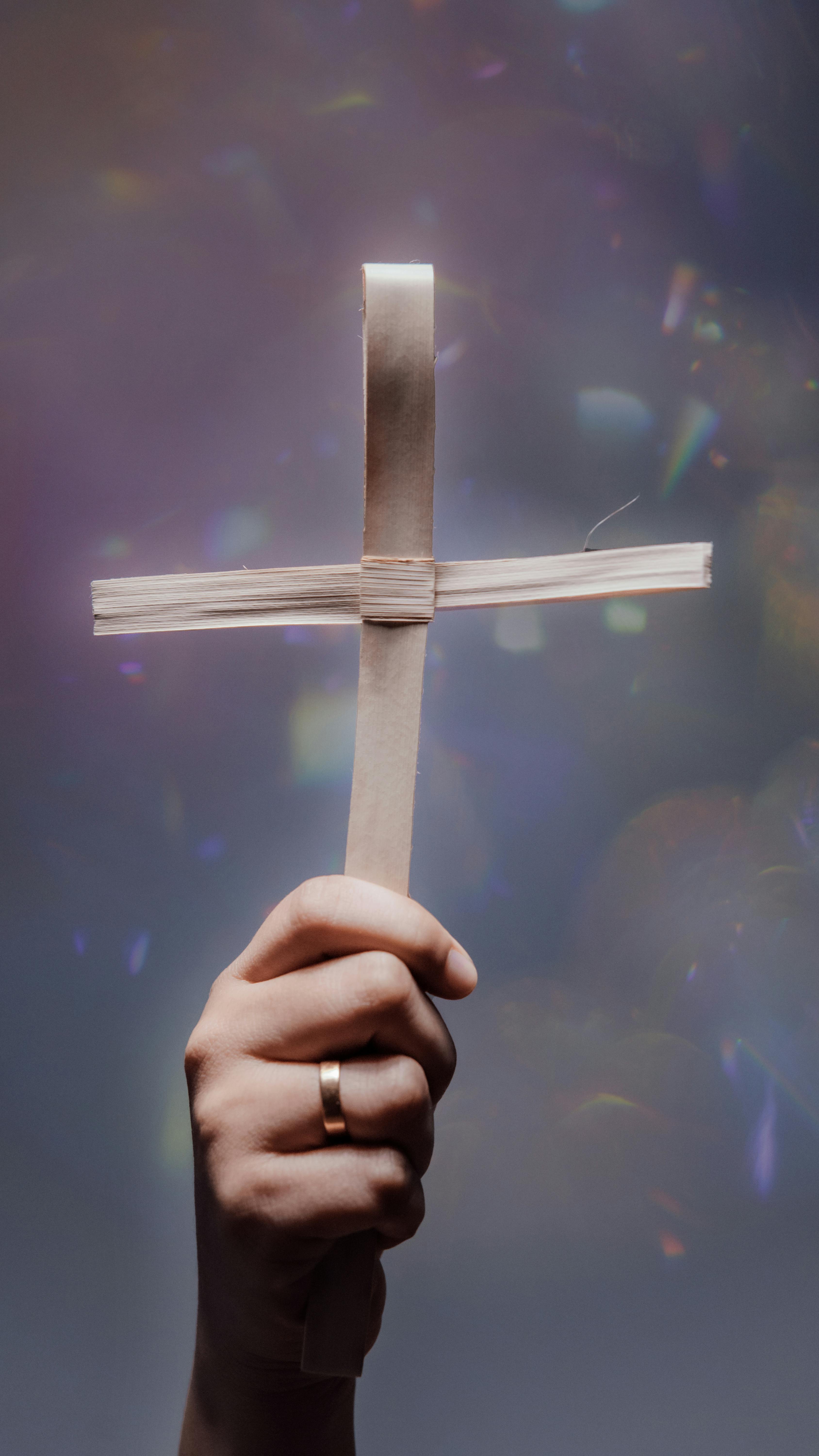 Photo of a Hand Holding a Crucifix · Free Stock Photo