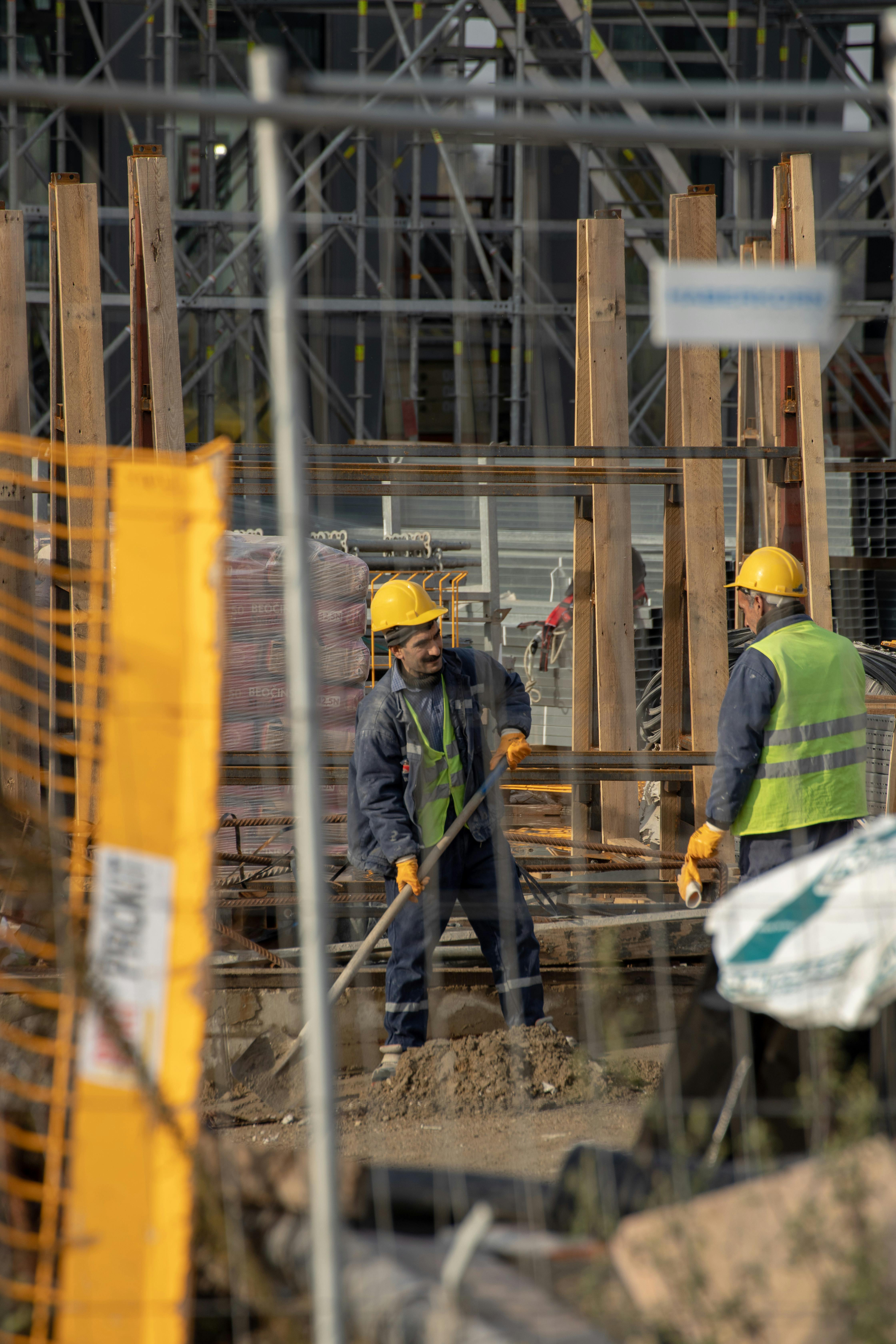 Builder Standing on Rebar at Construction Site · Free Stock Photo