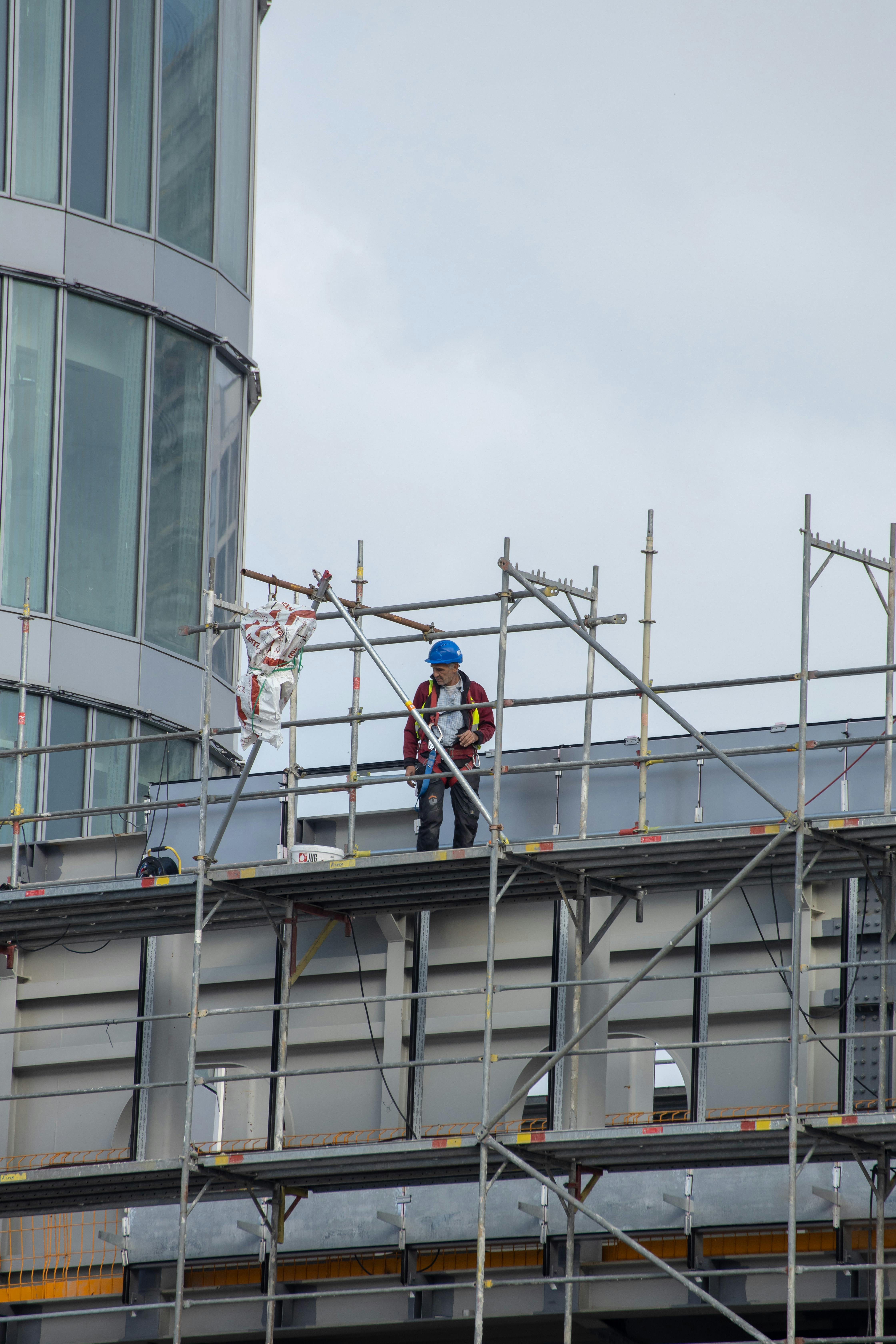 Men on Brown Scaffolding · Free Stock Photo