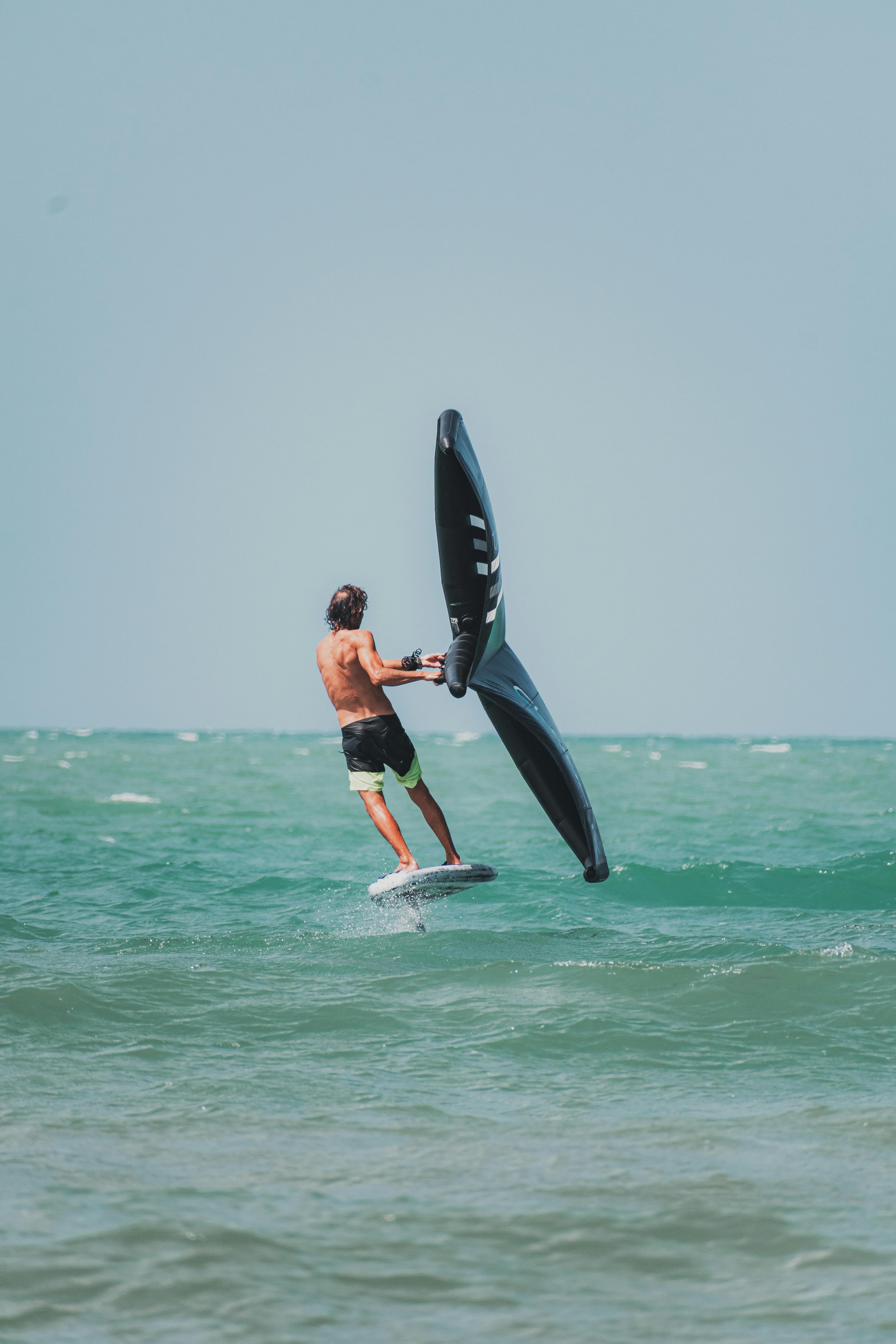 Surfboarding on Sea · Free Stock Photo