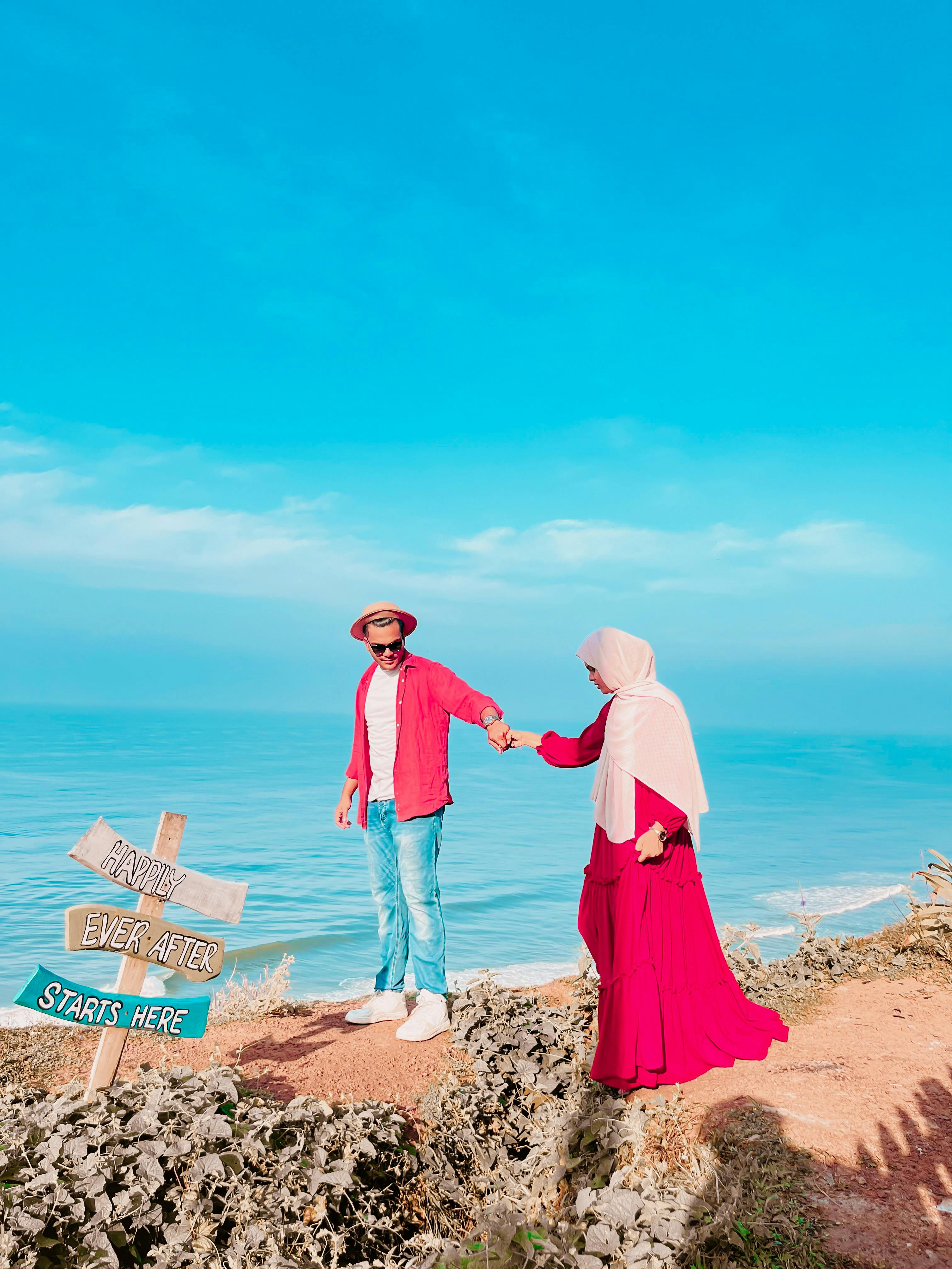 Man and Woman Standing and Holding Hands on the Beach · Free Stock Photo