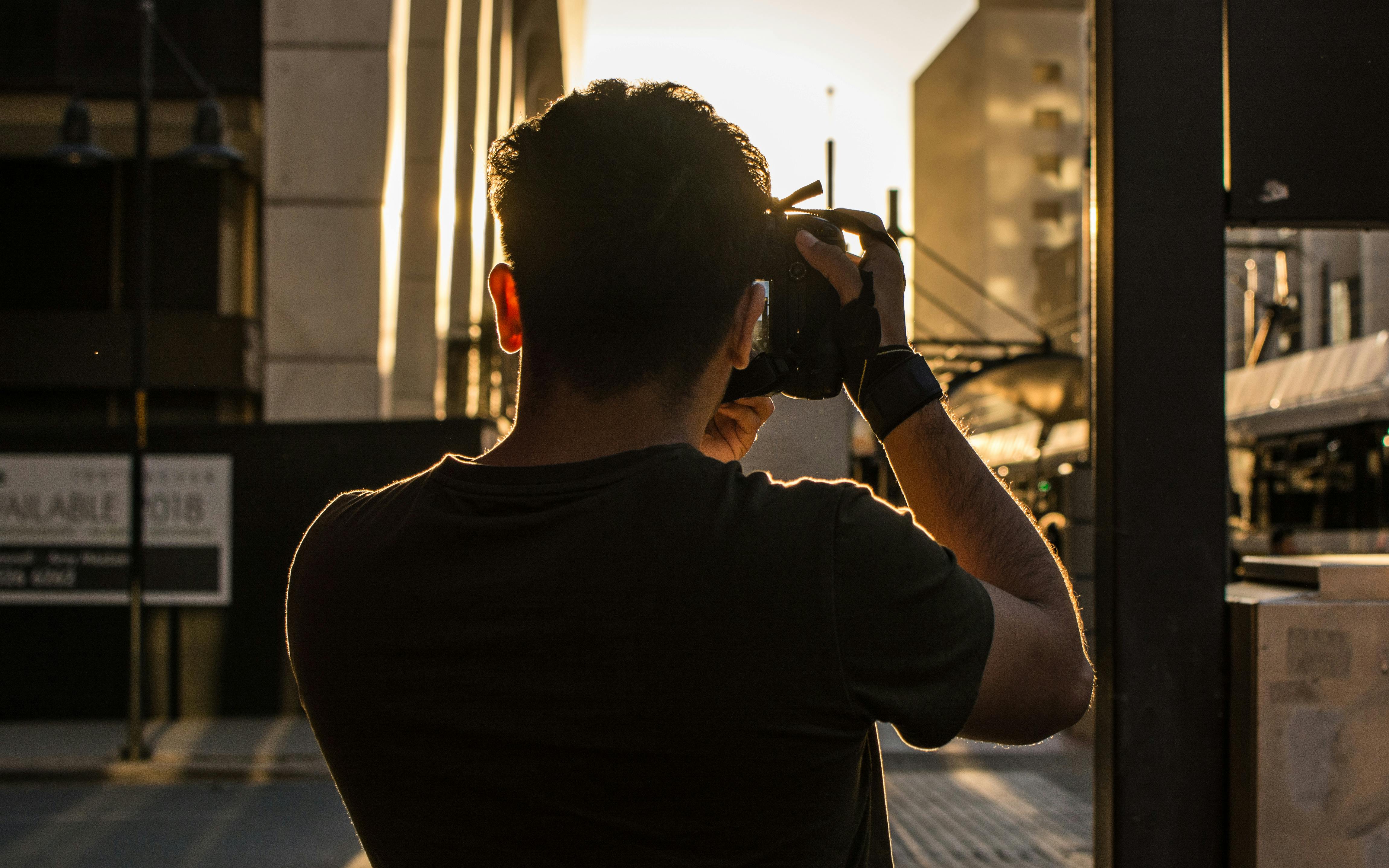 Back View of a Photographer Shooting Pictures · Free Stock Photo