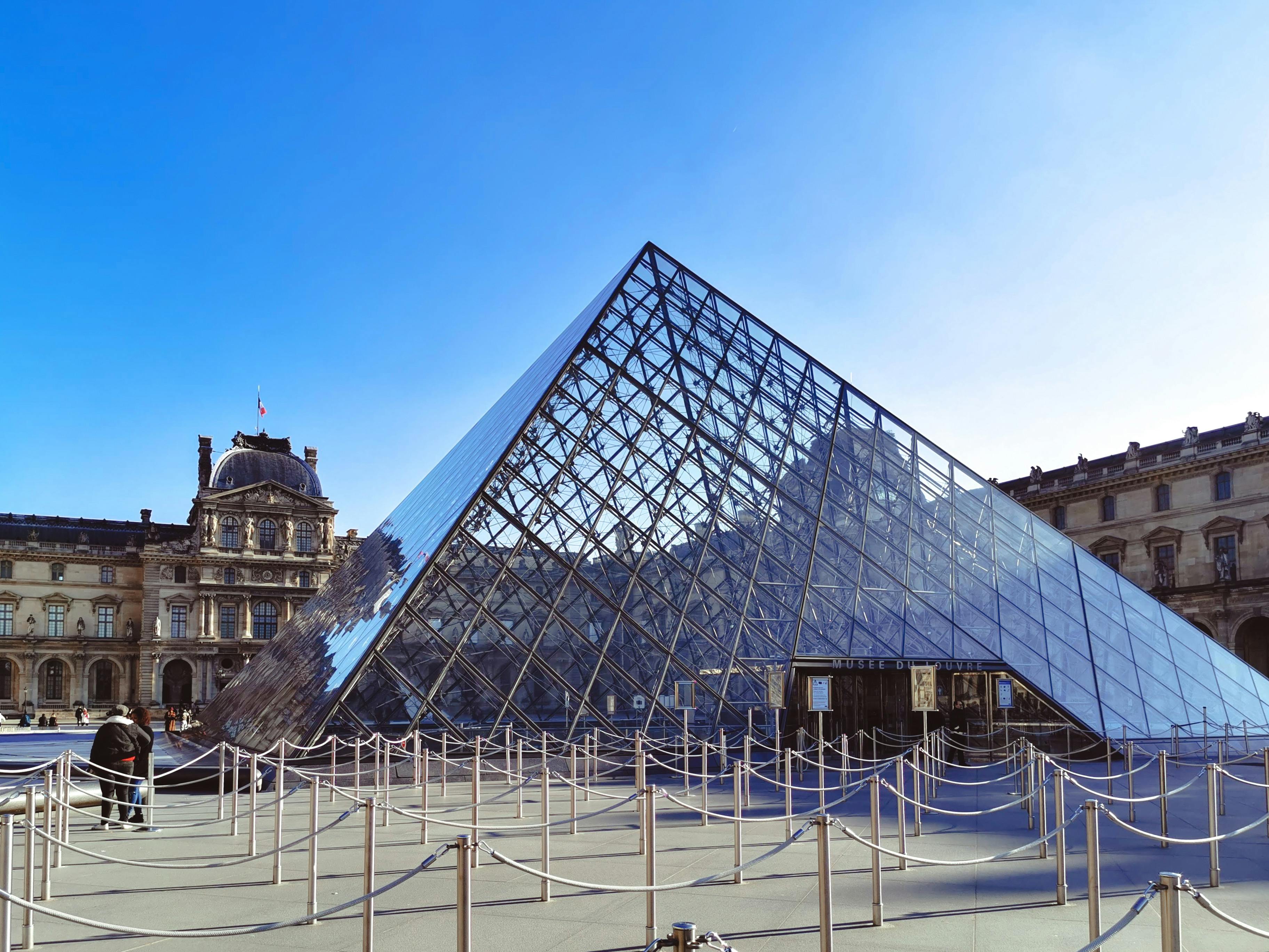 Metal Frame Glass Pyramid Outside a Museum With Yellow Lights during ...