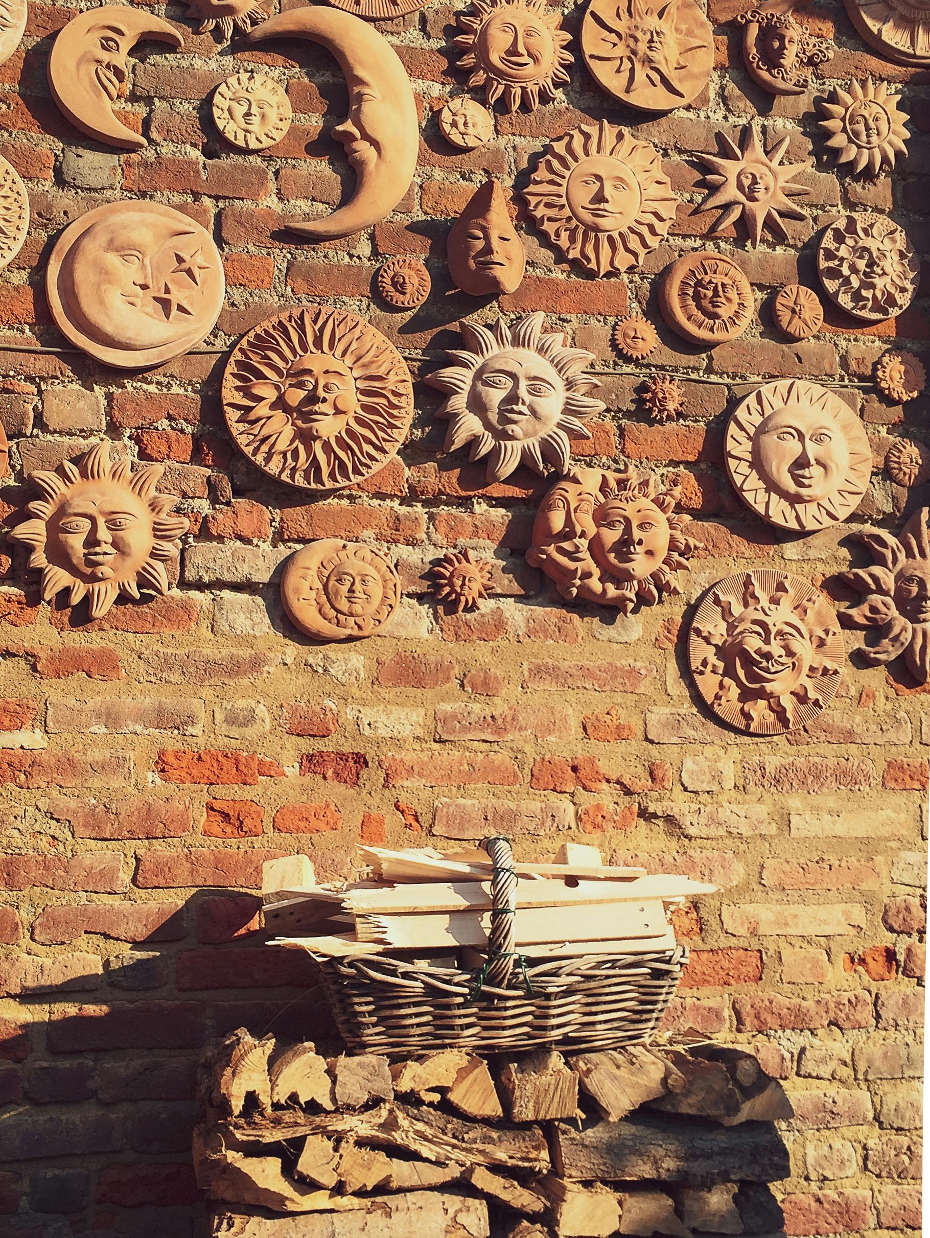 Terracotta Decorations Hanged on a Wall · Free Stock Photo