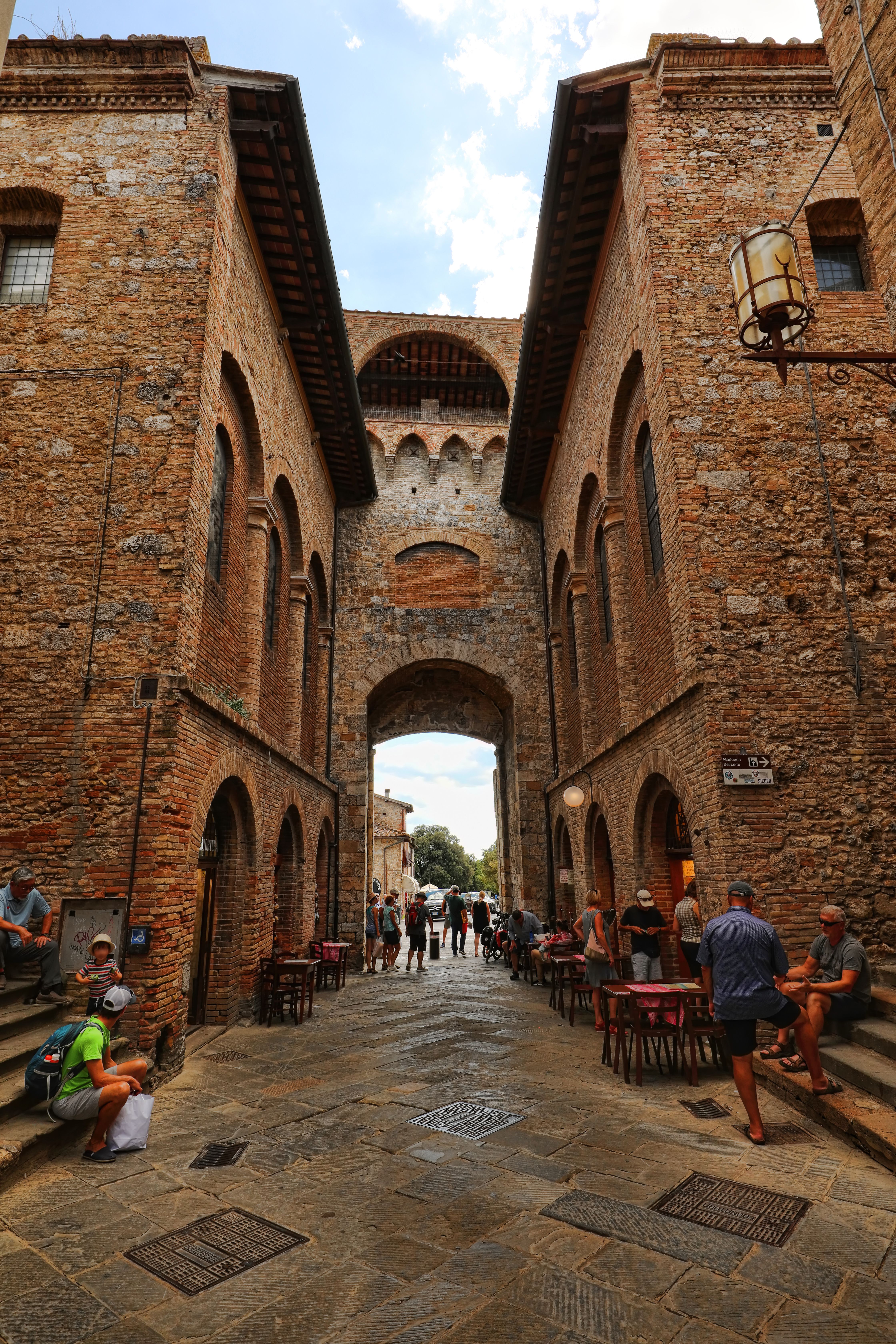 People Walking Beside Brick Buildings · Free Stock Photo