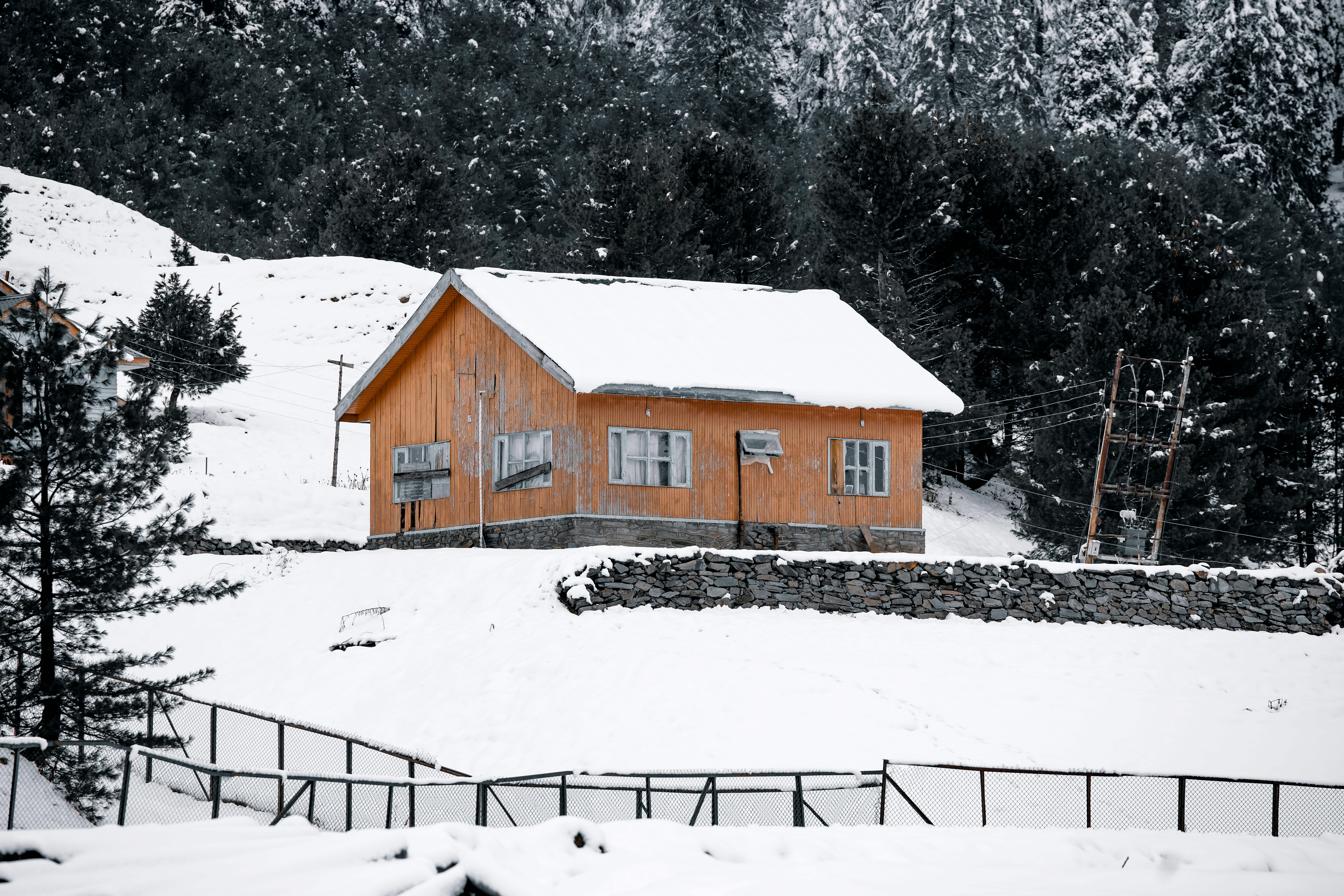 Brown House Beside Snow Covered Trees · Free Stock Photo