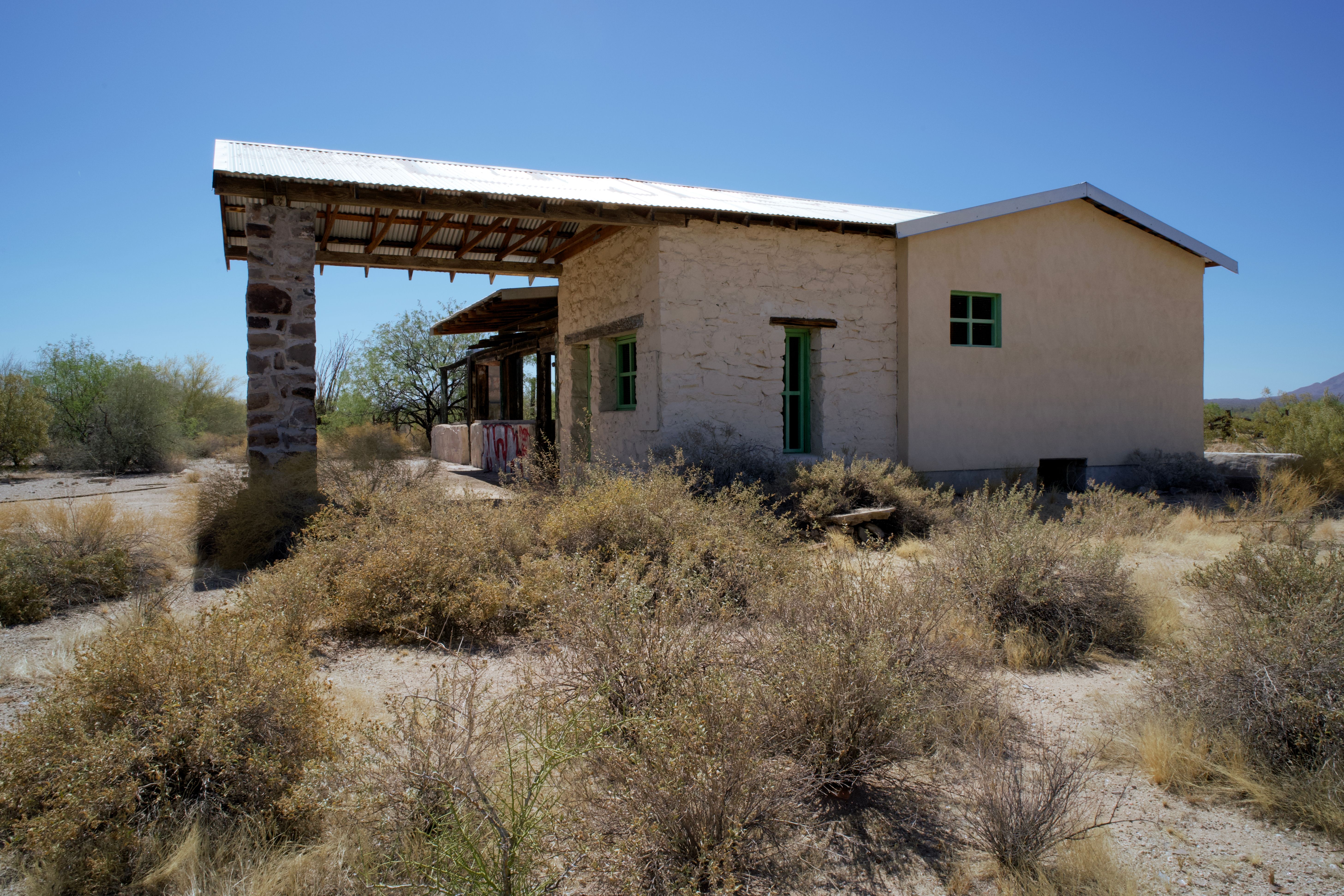 Abandoned Brick House on Rocky Wasteland · Free Stock Photo