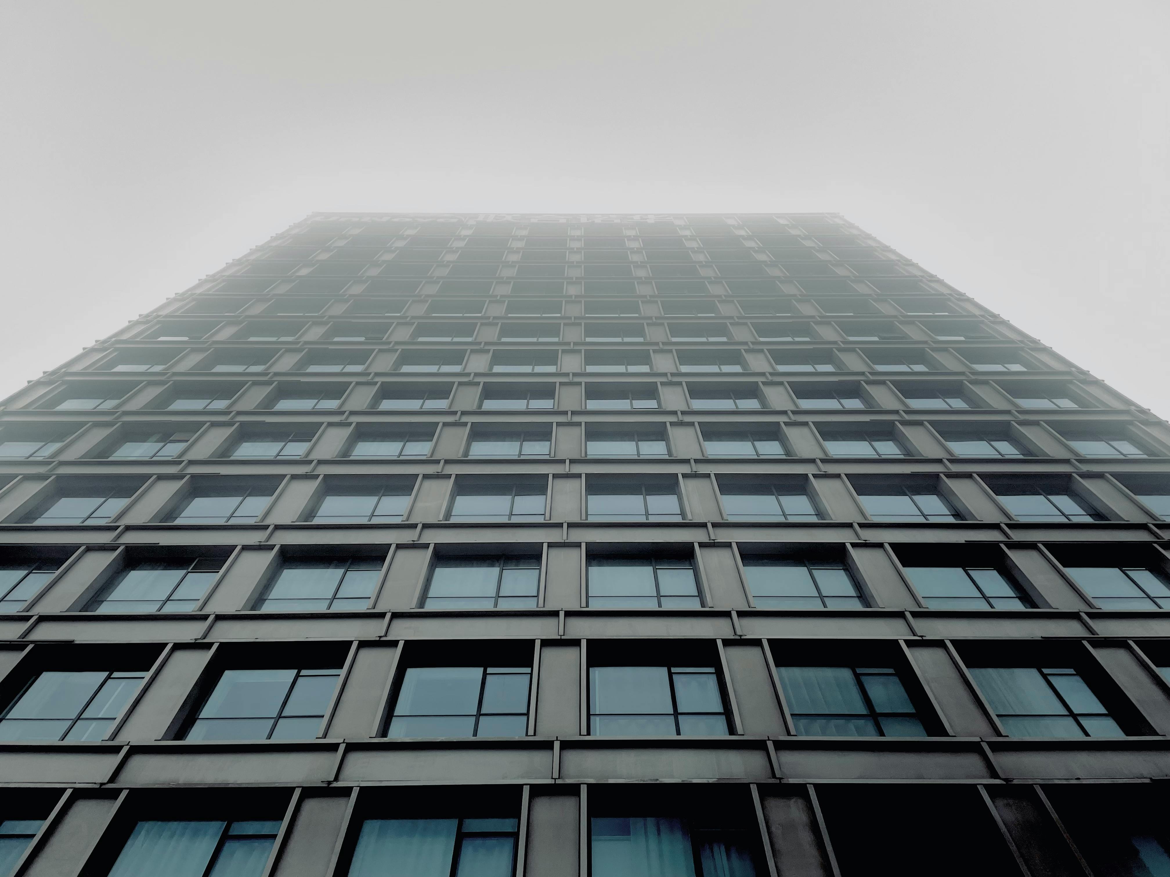 Concrete Building with Glass Panel Windows During a Foggy Day · Free ...