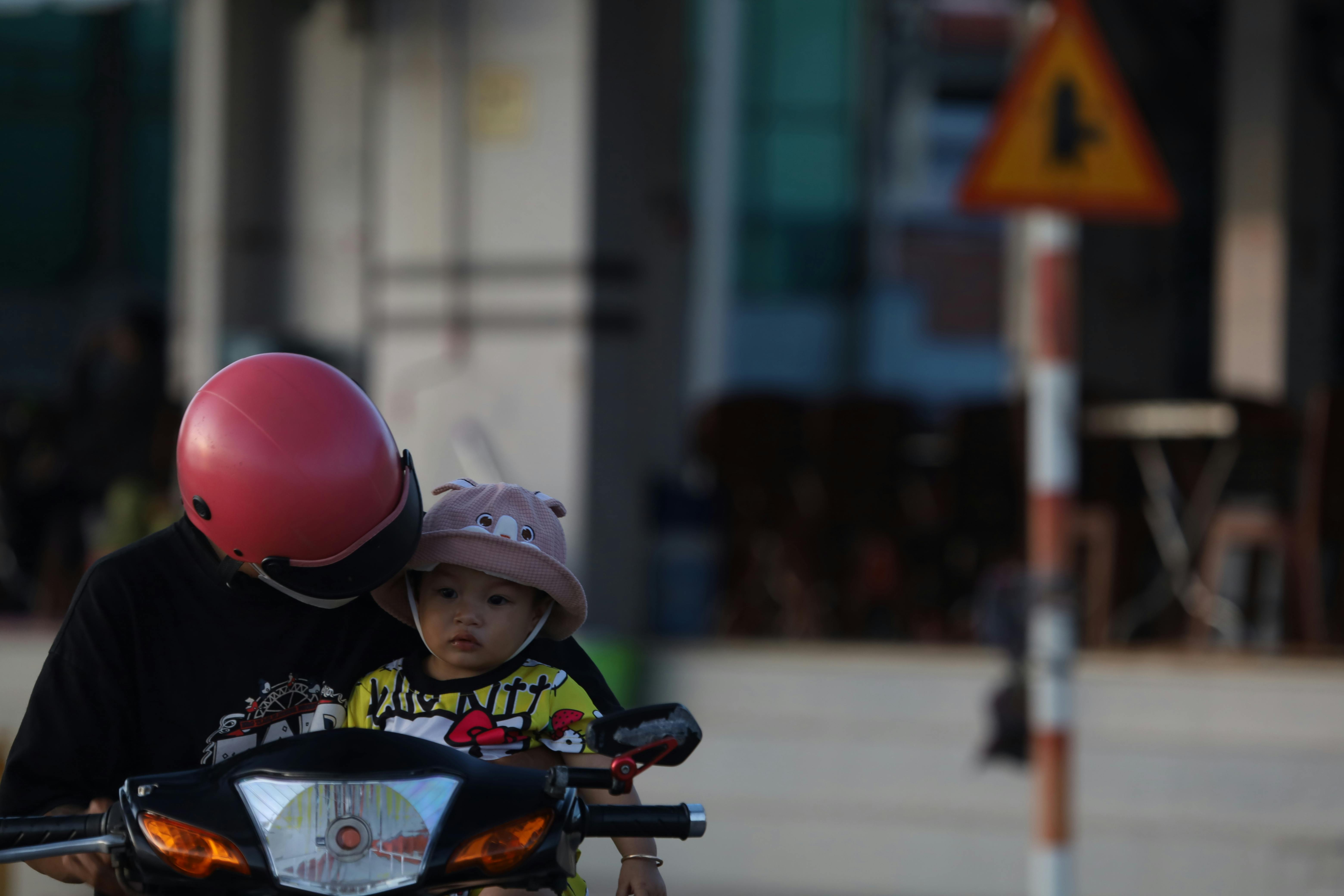 A Father with Kid in a Motorcycle · Free Stock Photo