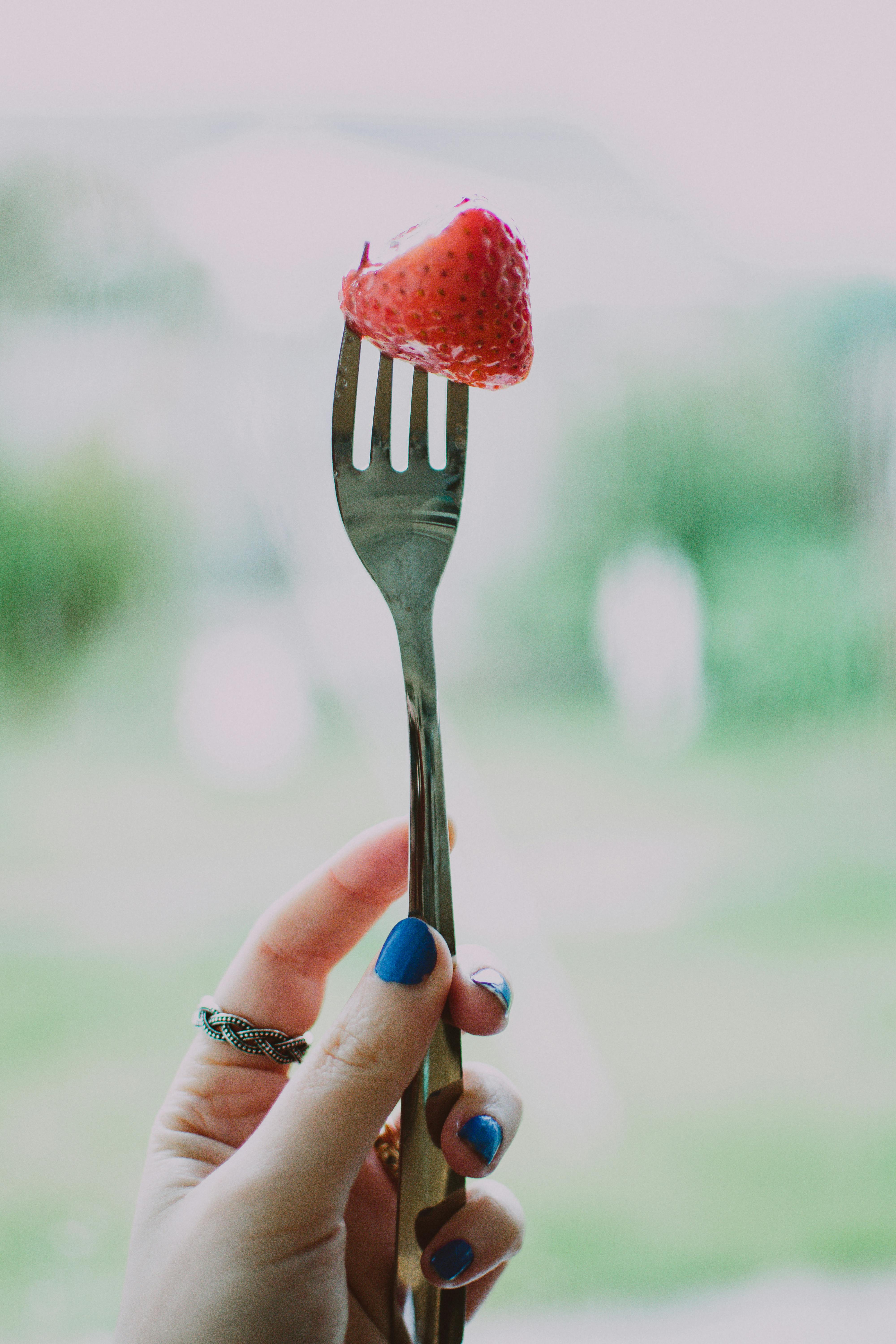 Person Holding Gray Steel Fork With Strawberry · Free Stock Photo