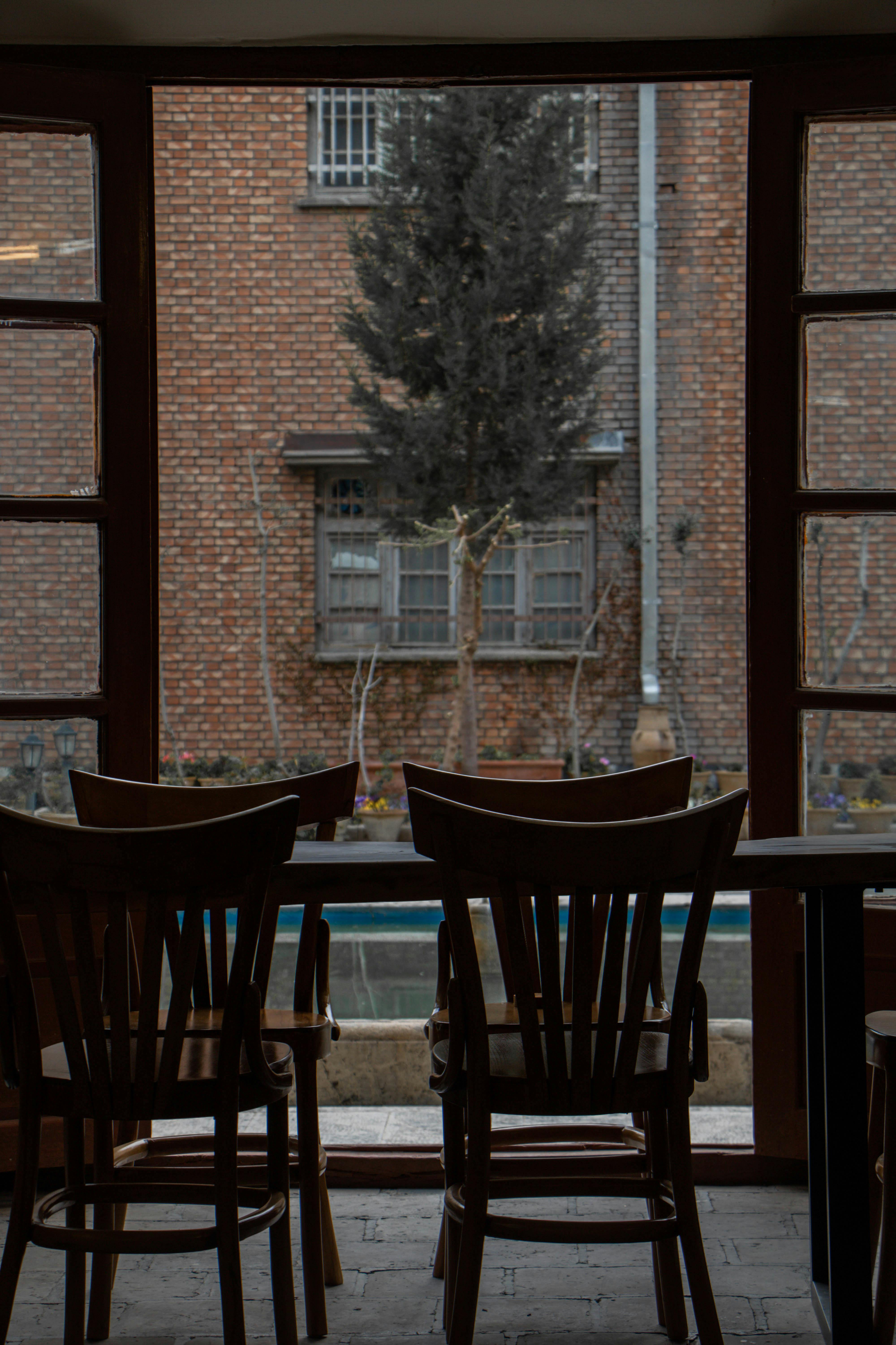 Restaurant Interior with a Window View of a Redbrick Building · Free ...