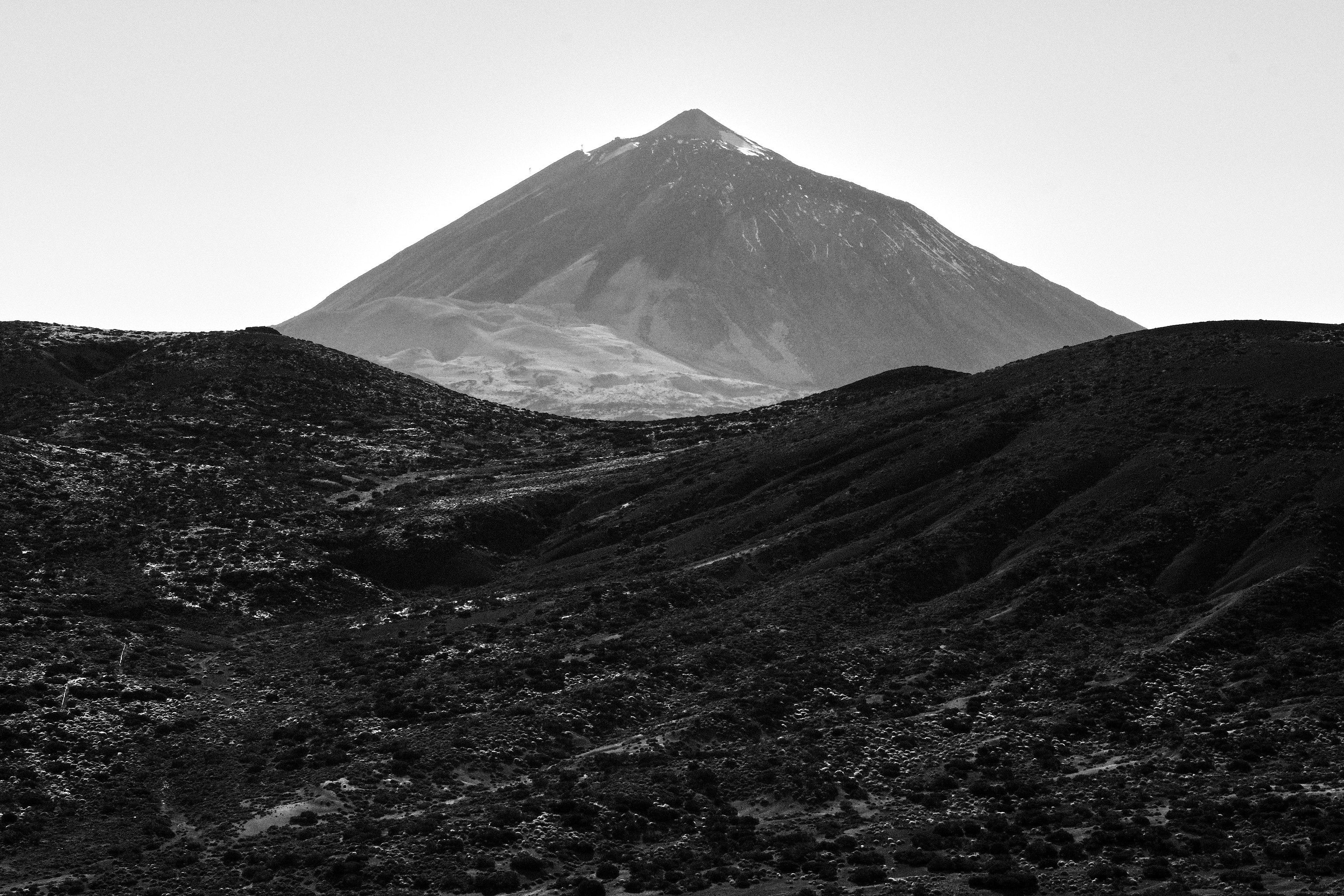 A Grayscale Photo of a Mountain Under the Clear Sky · Free Stock Photo
