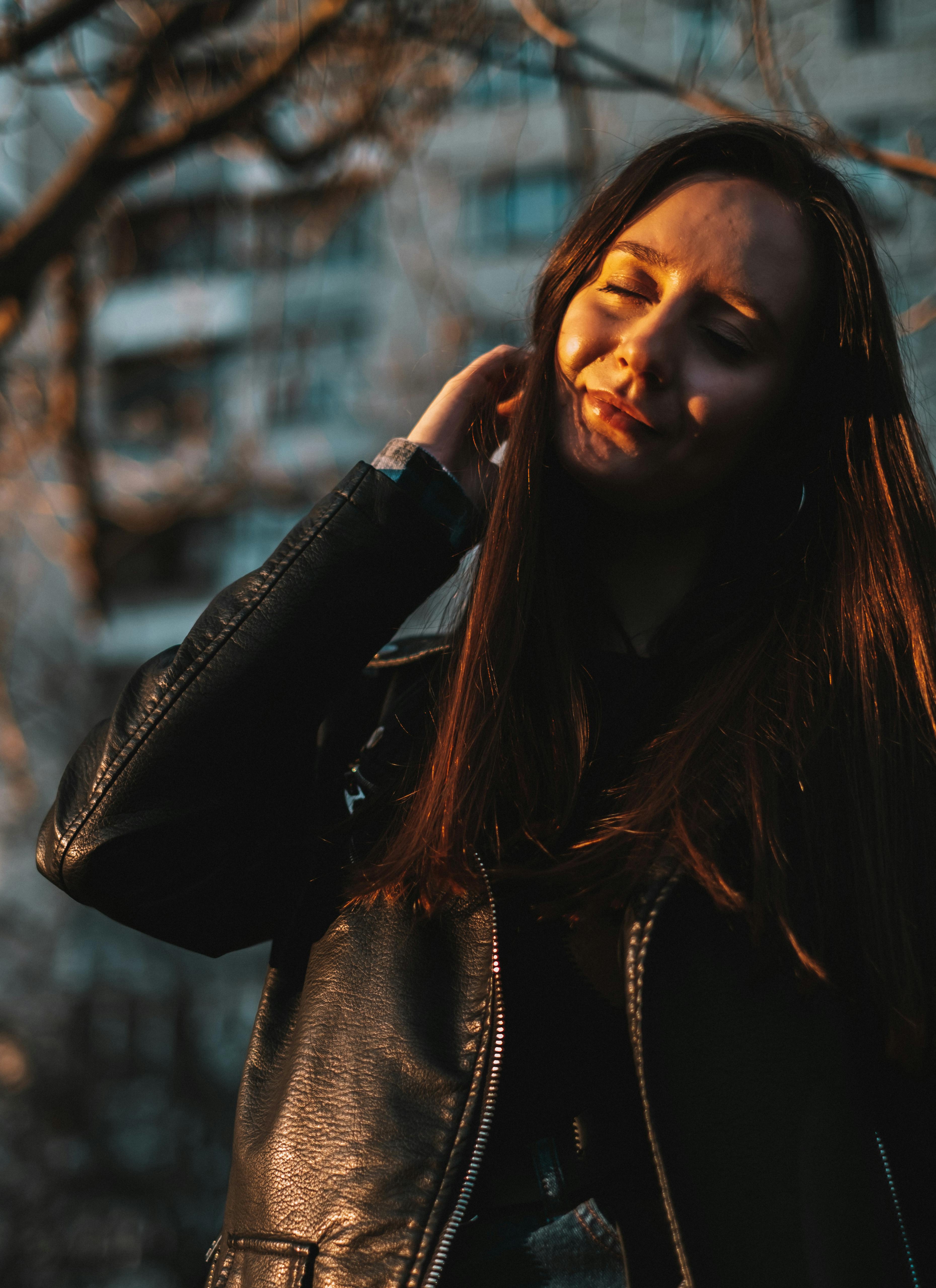Woman in a Black Leather Jacket Closing Her Eyes · Free Stock Photo