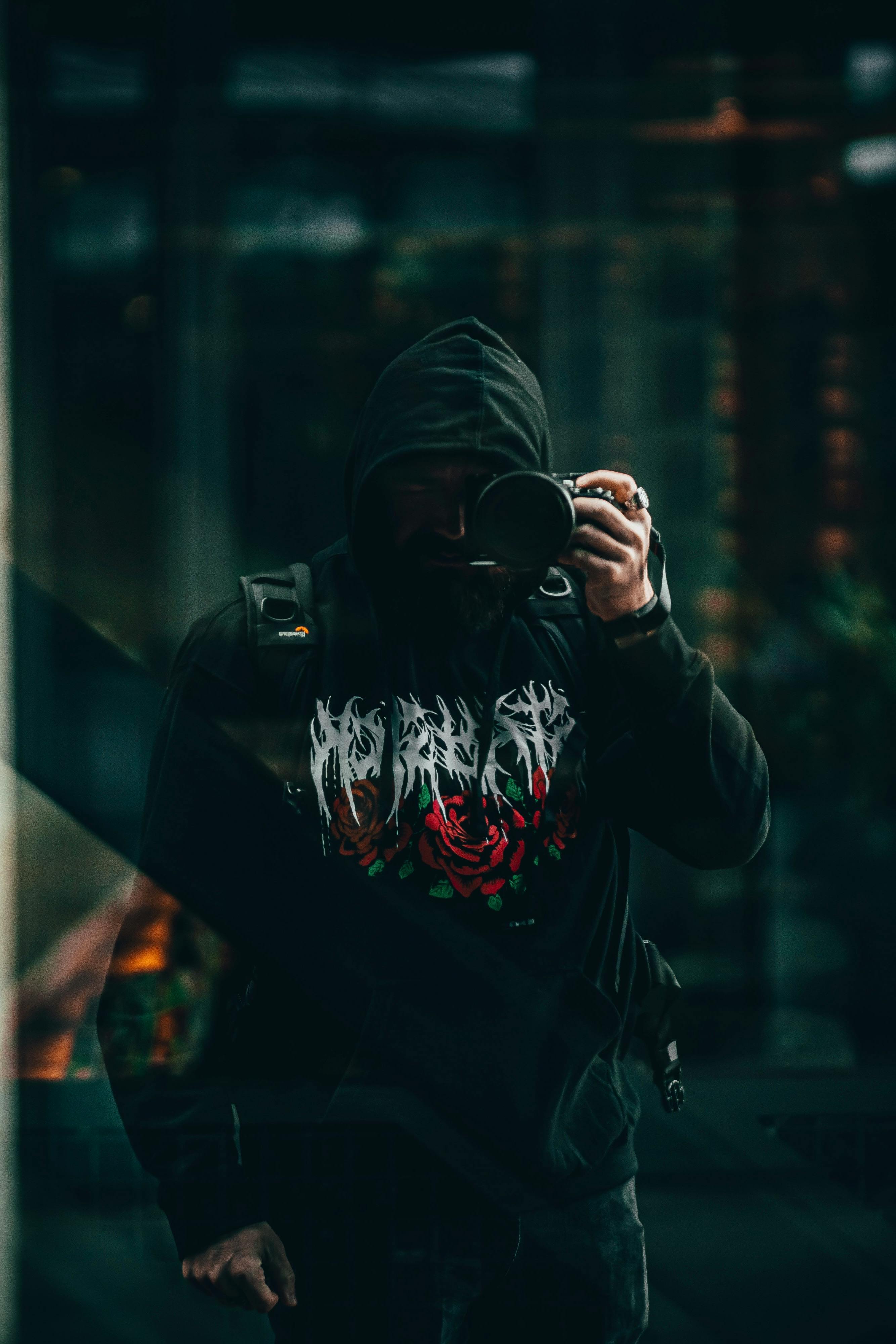 Man In A Jacket Holding Camera · Free Stock Photo