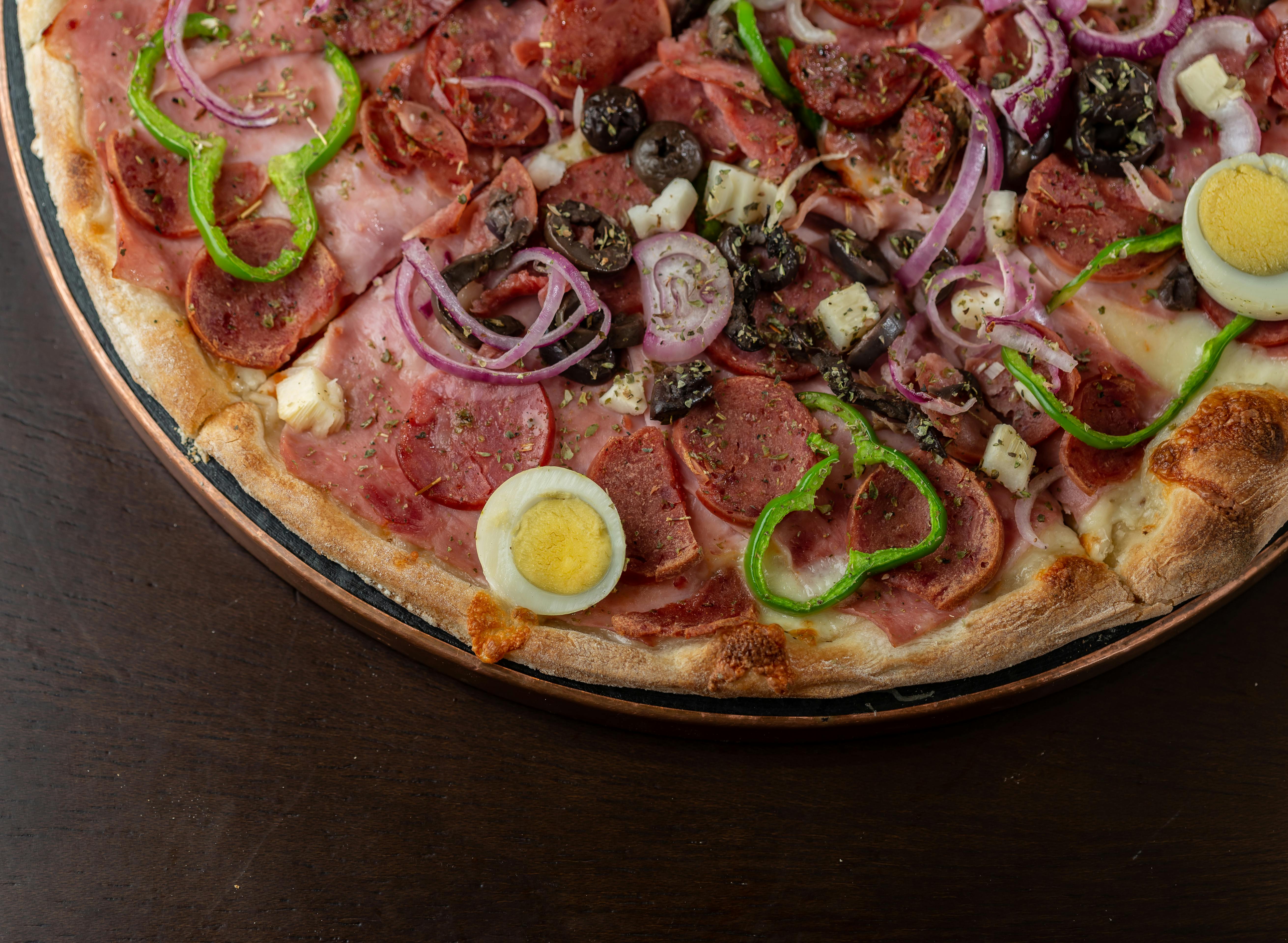 Close-Up Photo of People Getting a Pizza Slice · Free Stock Photo