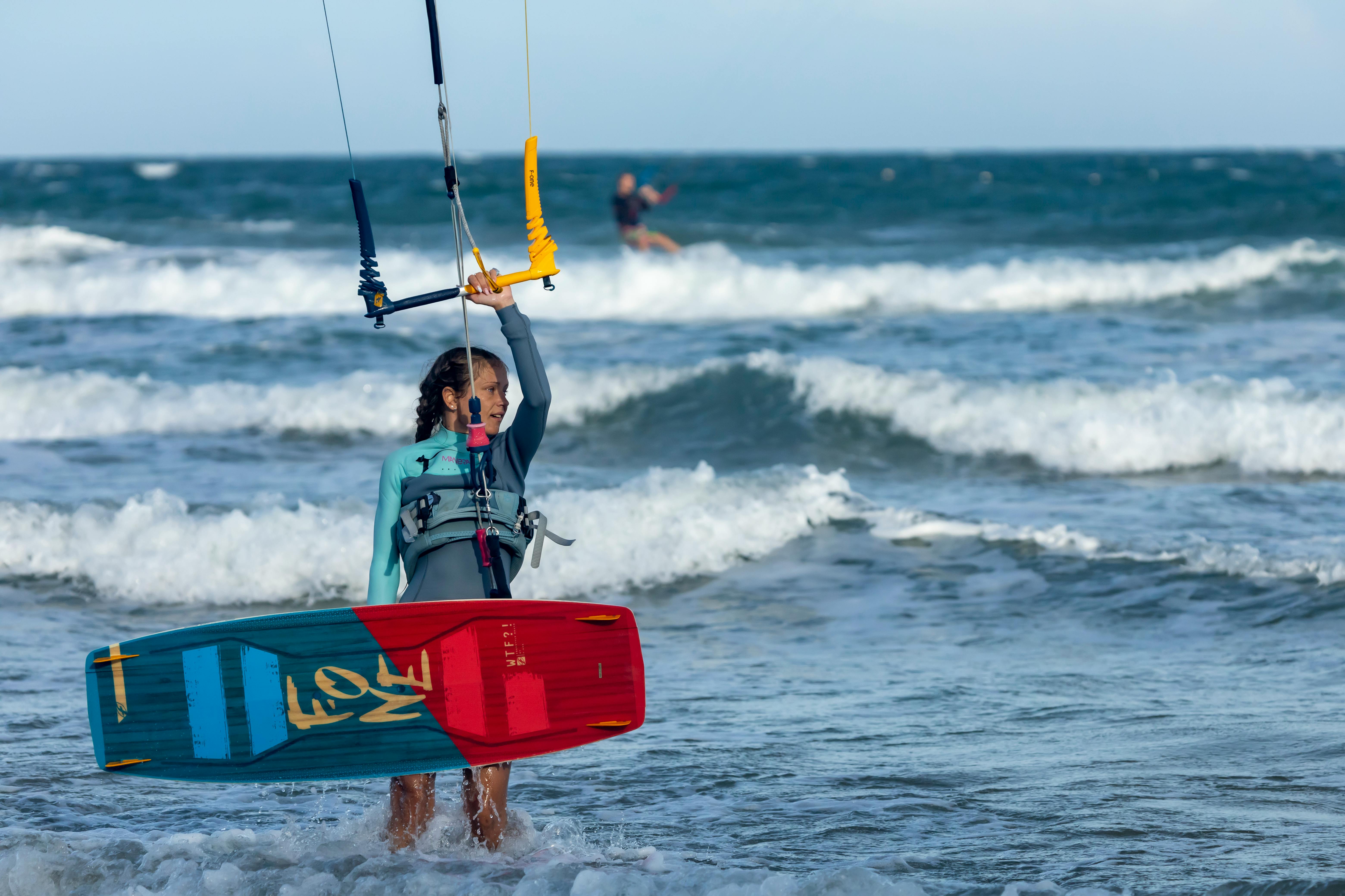Girl and person during Surfboarding · Free Stock Photo