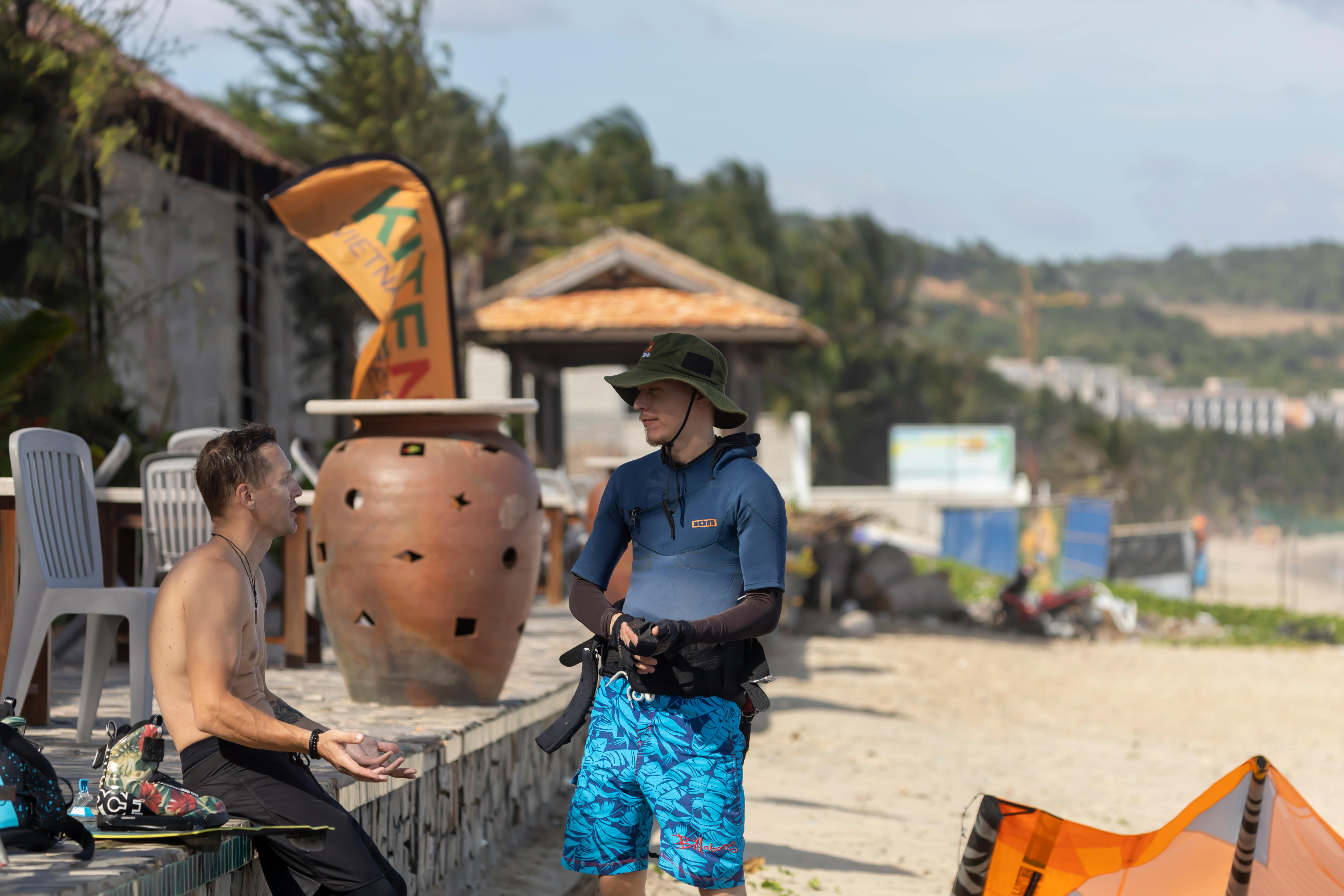 Men Talking in Seaside Cafe · Free Stock Photo