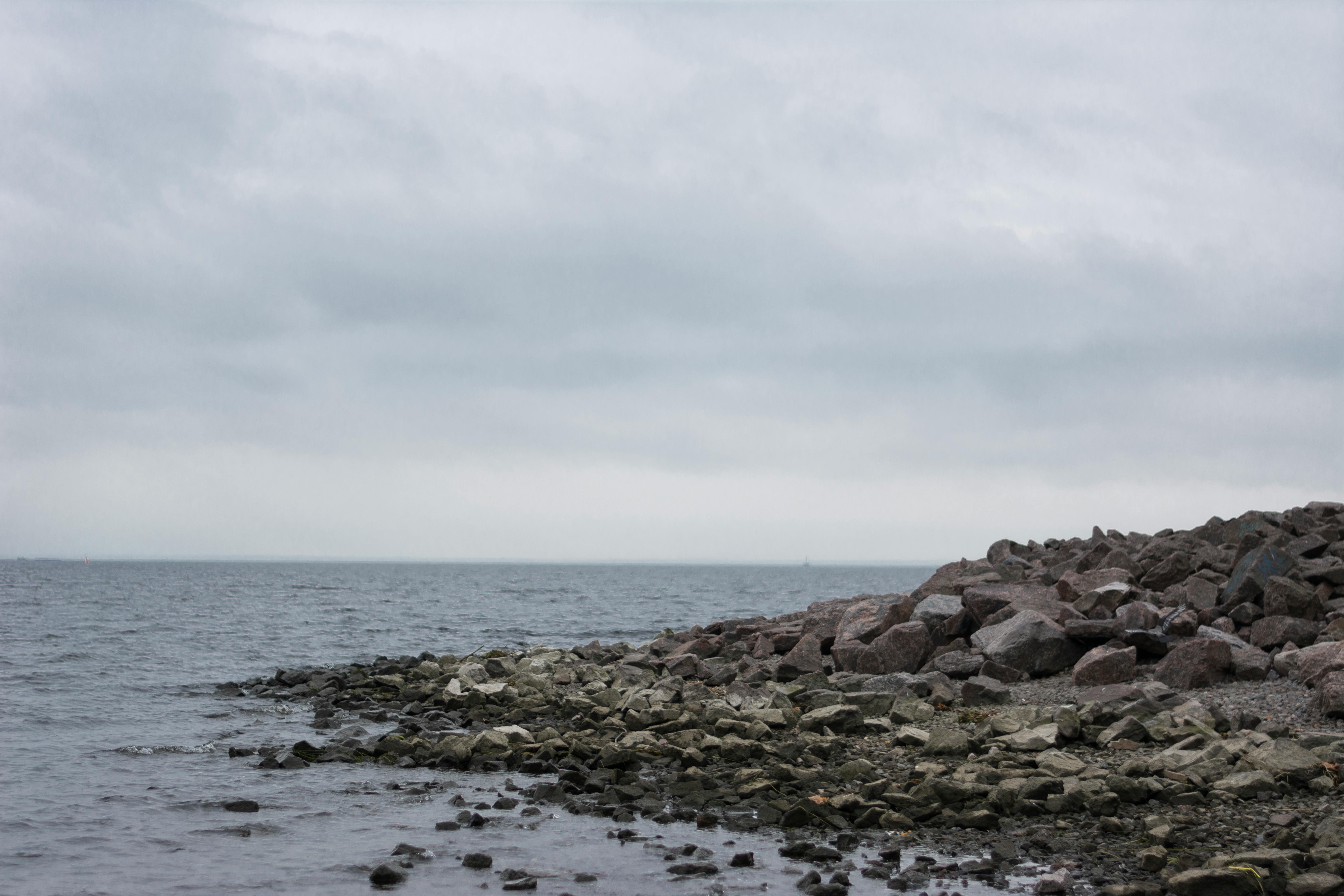 Rocks Piling on Sea Shore · Free Stock Photo