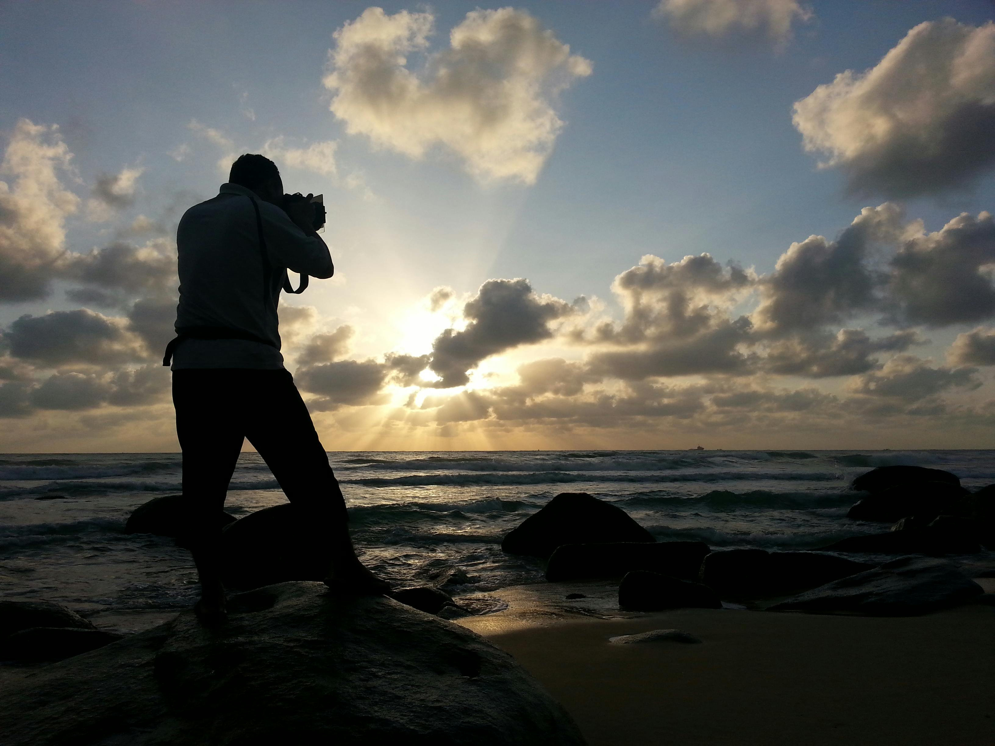 Person Capturing Photo Near Sea Under Clear Blue and White Cloudy Sky ...