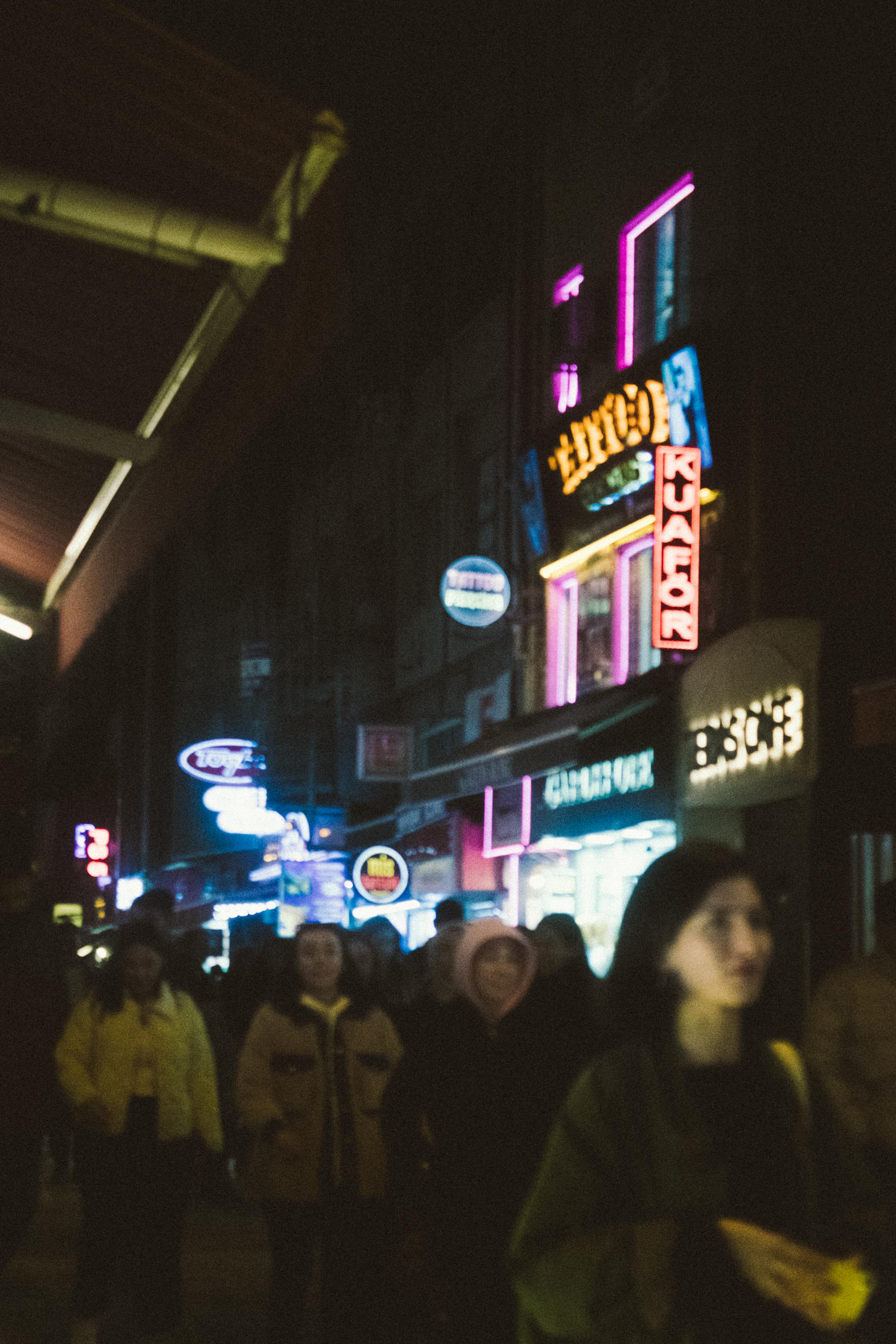 People Walking on the Street Between Shops · Free Stock Photo