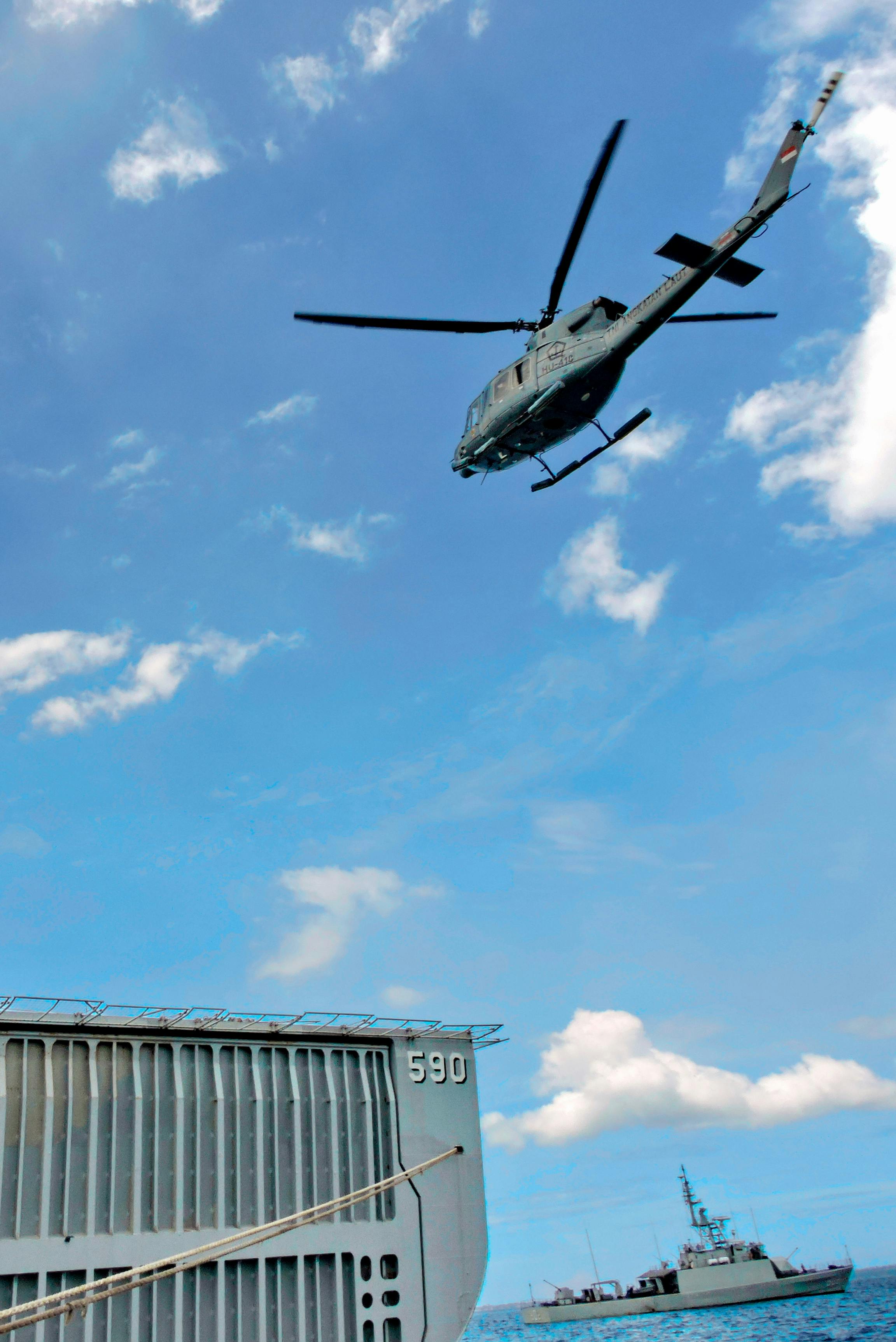Military Helicopter Flying over Ship · Free Stock Photo