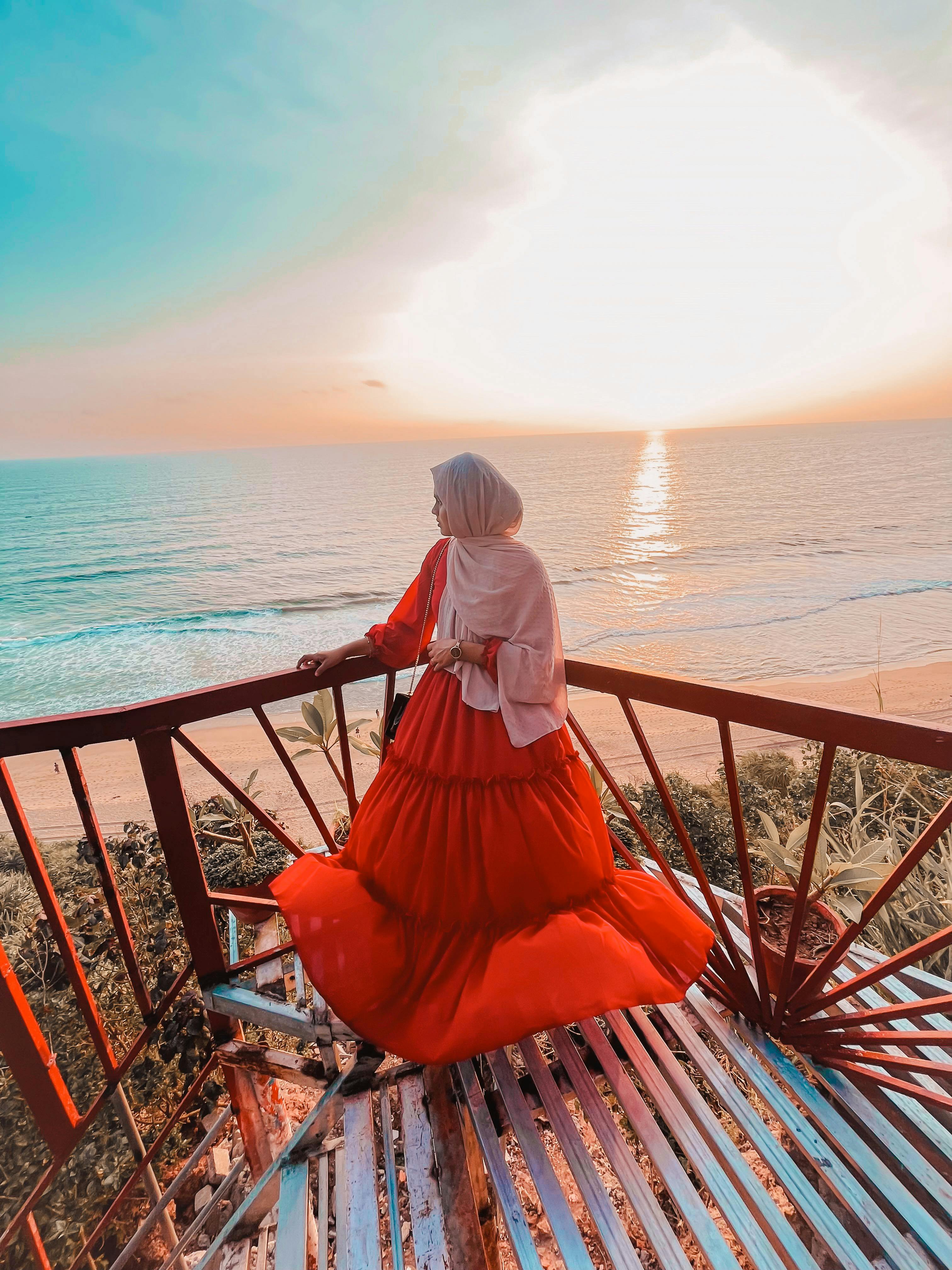 Woman Standing on a Balcony with a View of the Sea · Free Stock Photo