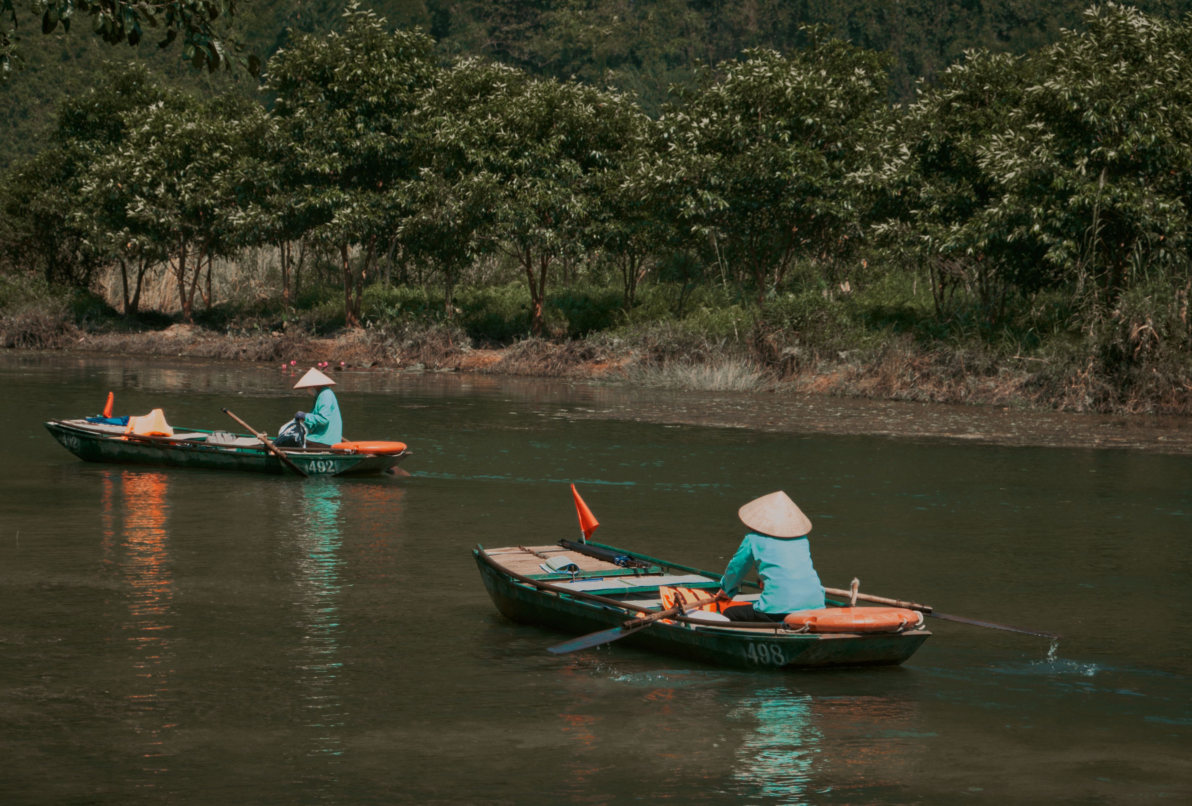 Women Wearing Conical Hat Riding a Wooden Boat · Free Stock Photo