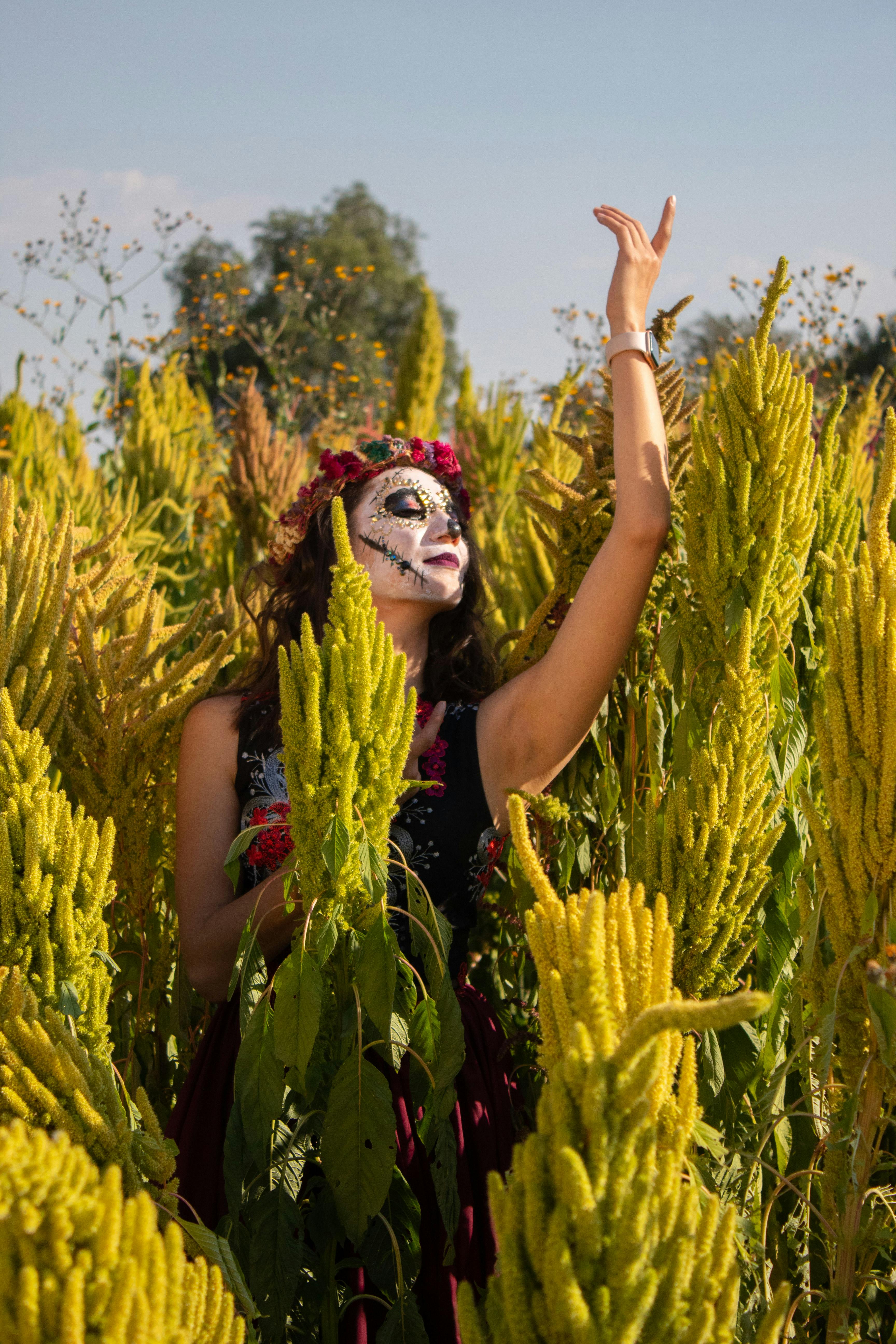 A Woman with Face Paint at a Field of Amaranth Plants · Free Stock Photo