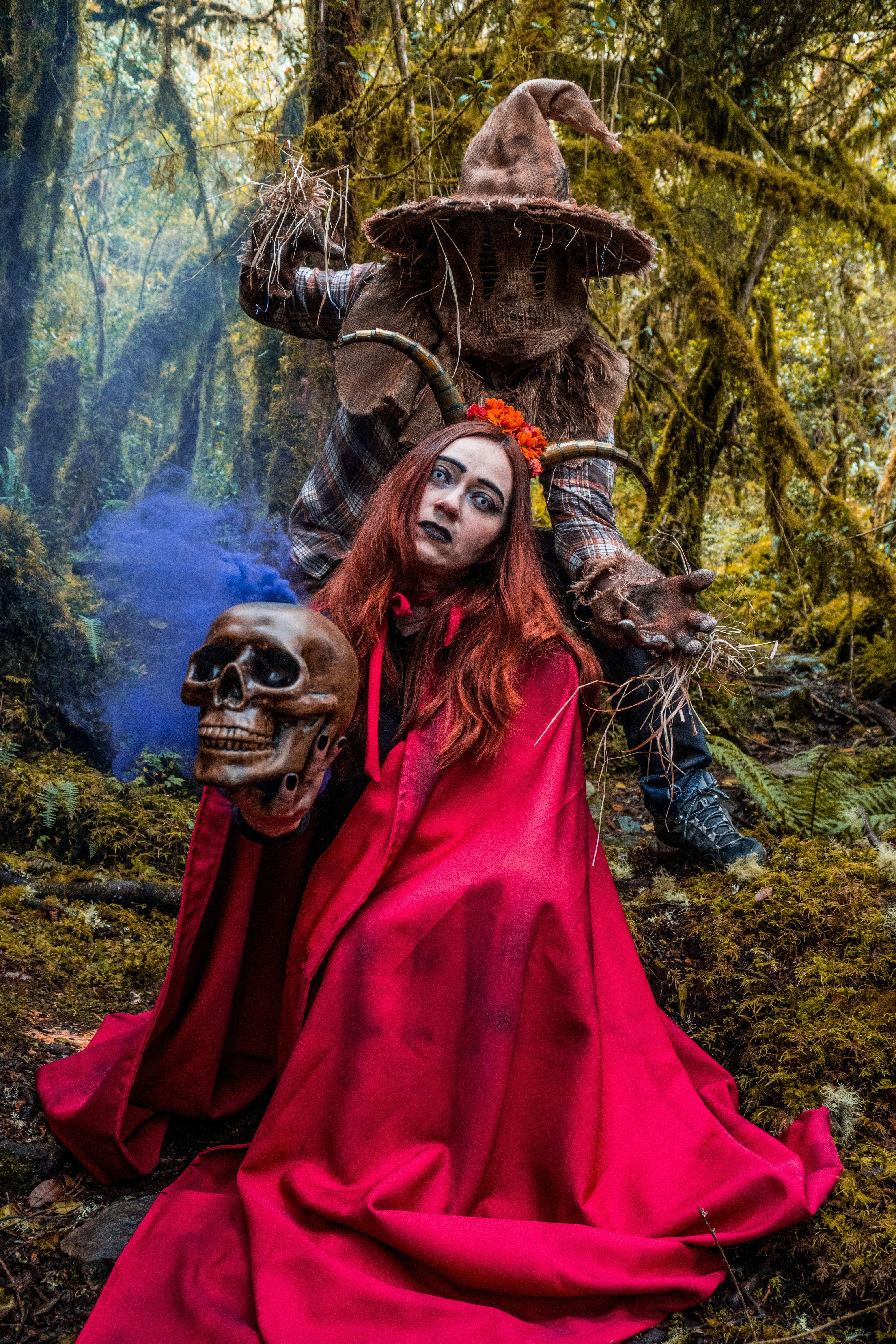 Woman in a Halloween Costume with Horns and Red Cape and Man in a ...