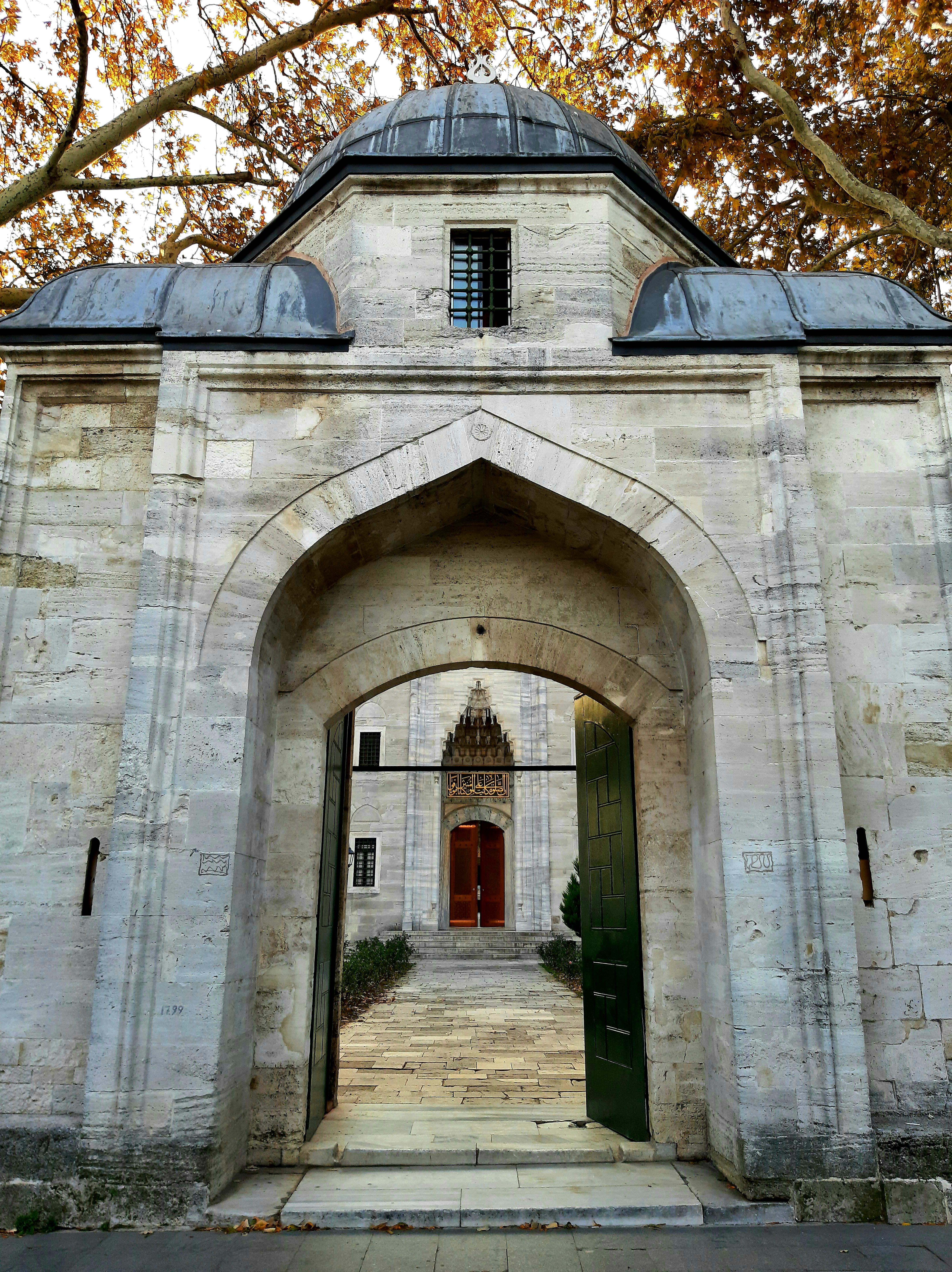 Stone Entrance Gate Leading to Church Building · Free Stock Photo