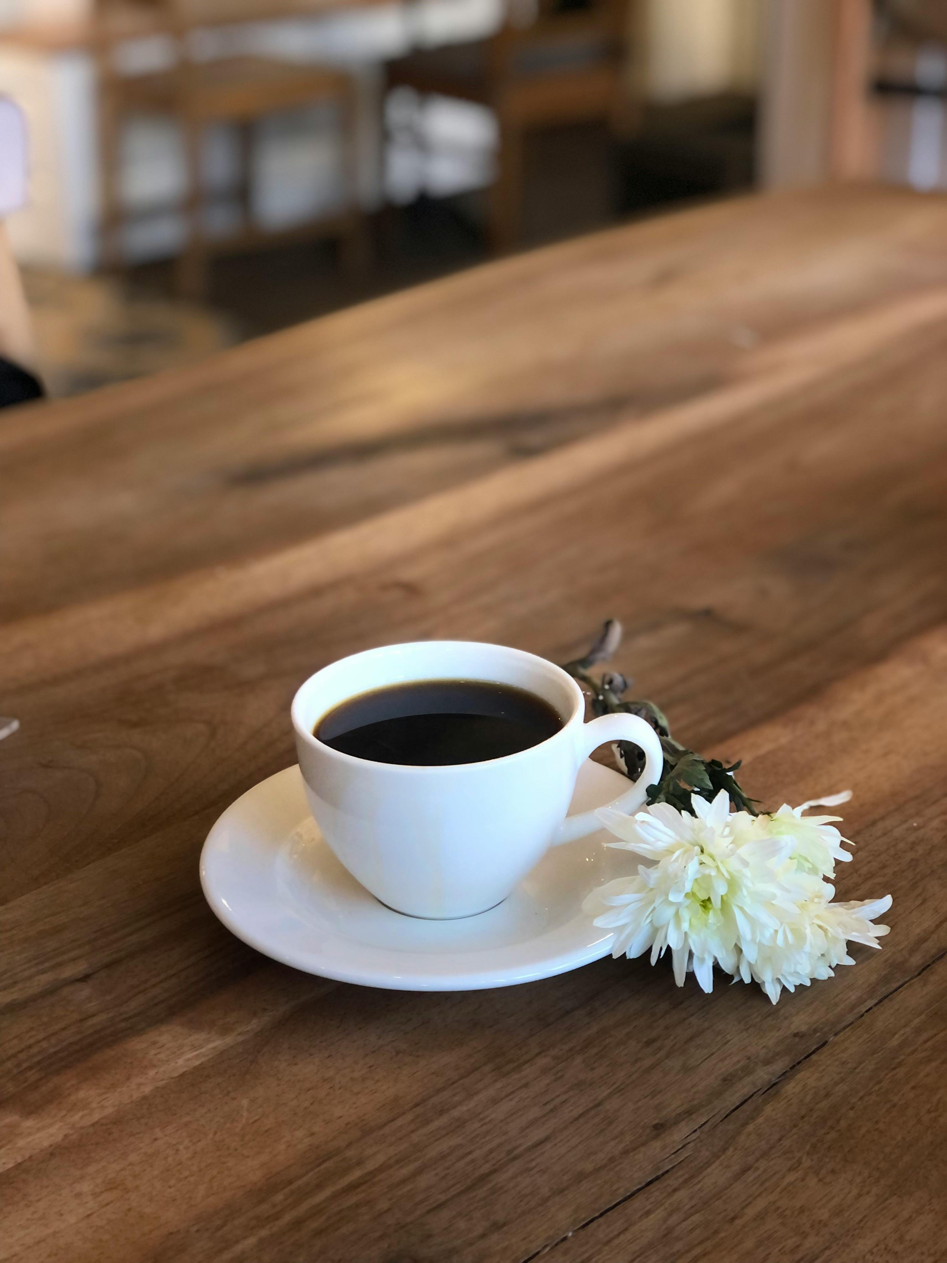A Cup of Coffee on a White Table · Free Stock Photo