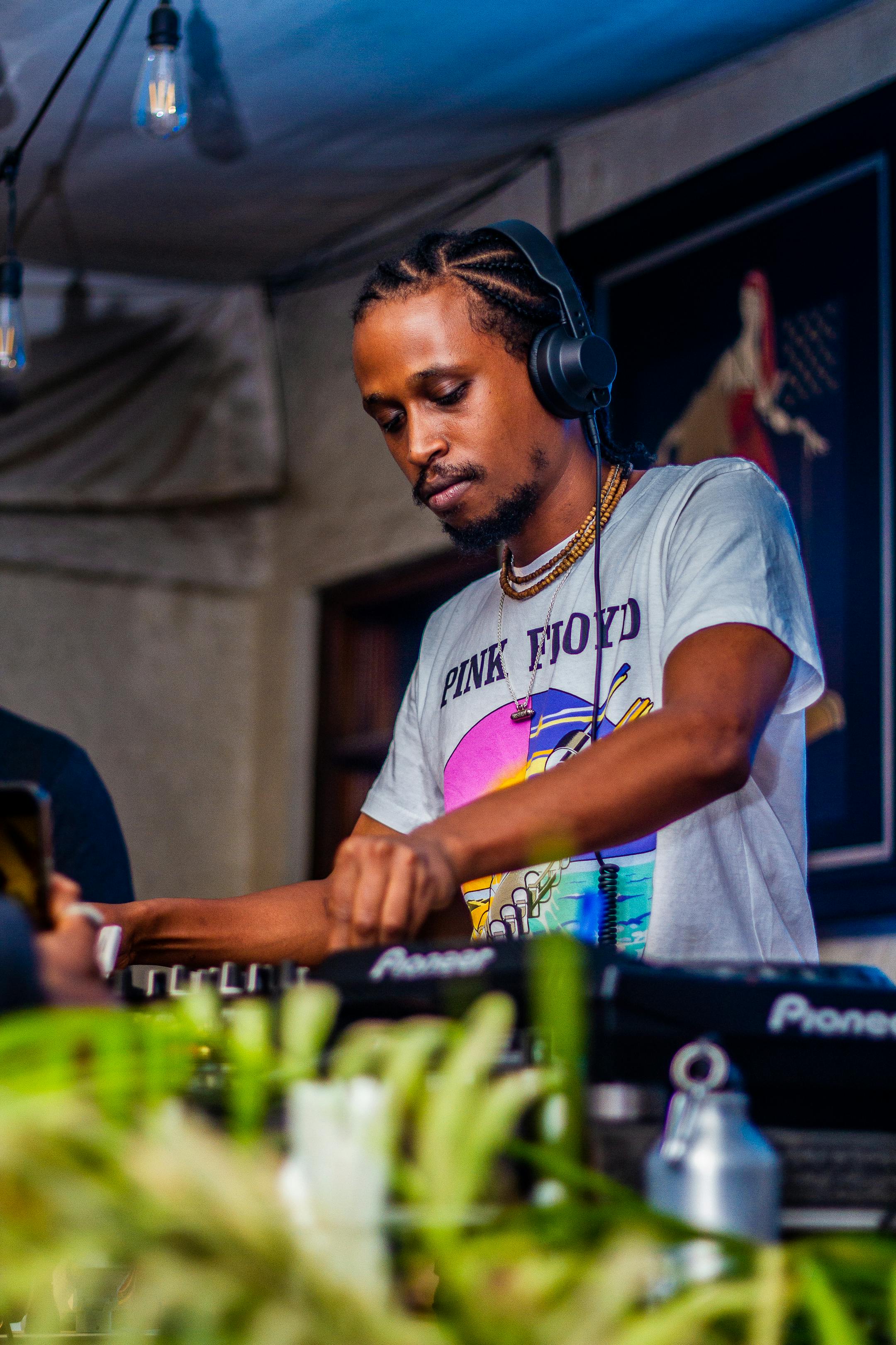 Monochrome Shot of a Man Using DJ Mixer · Free Stock Photo