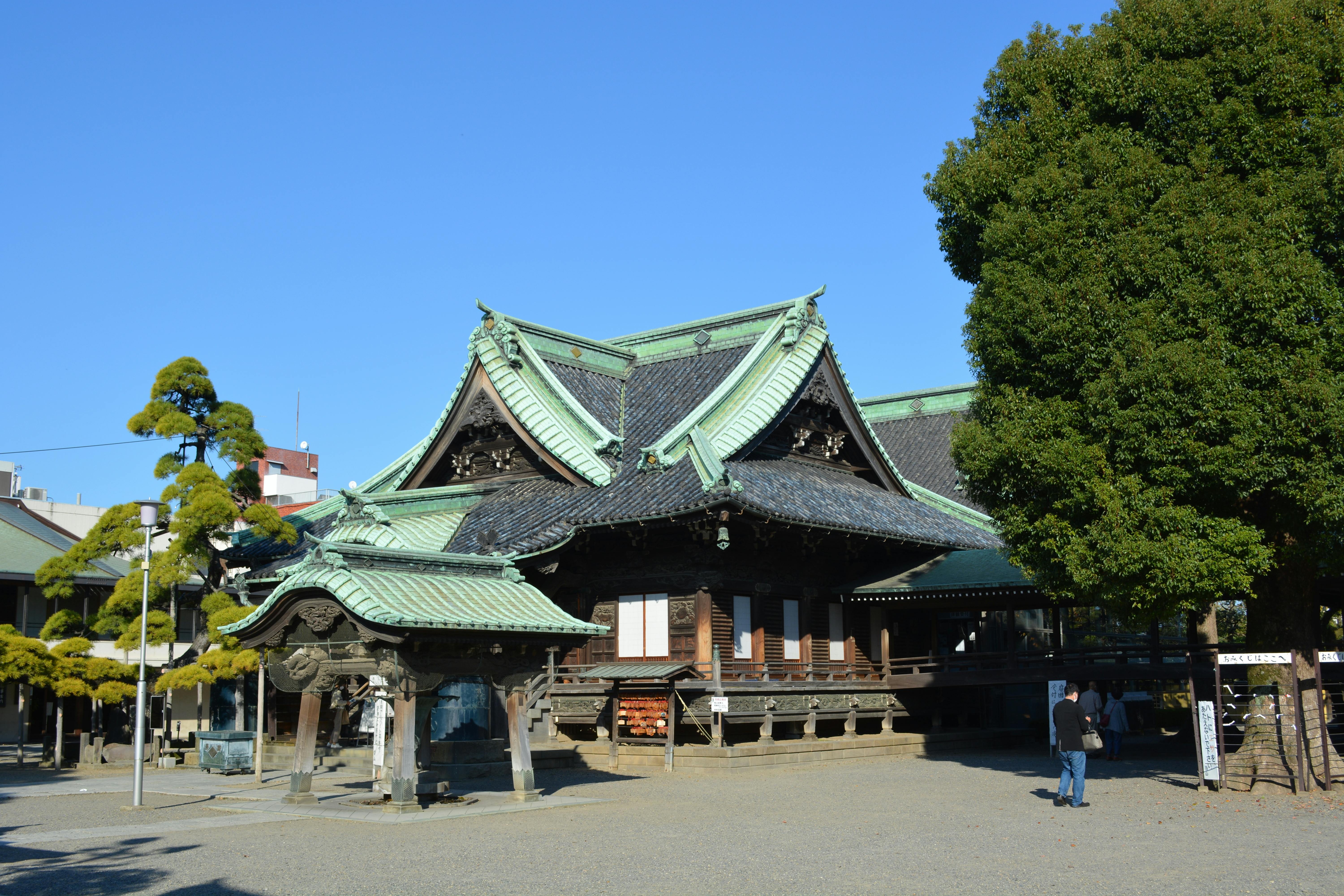 Red and Blue Temple Behind Green Leaf Trees at Daytime · Free Stock Photo