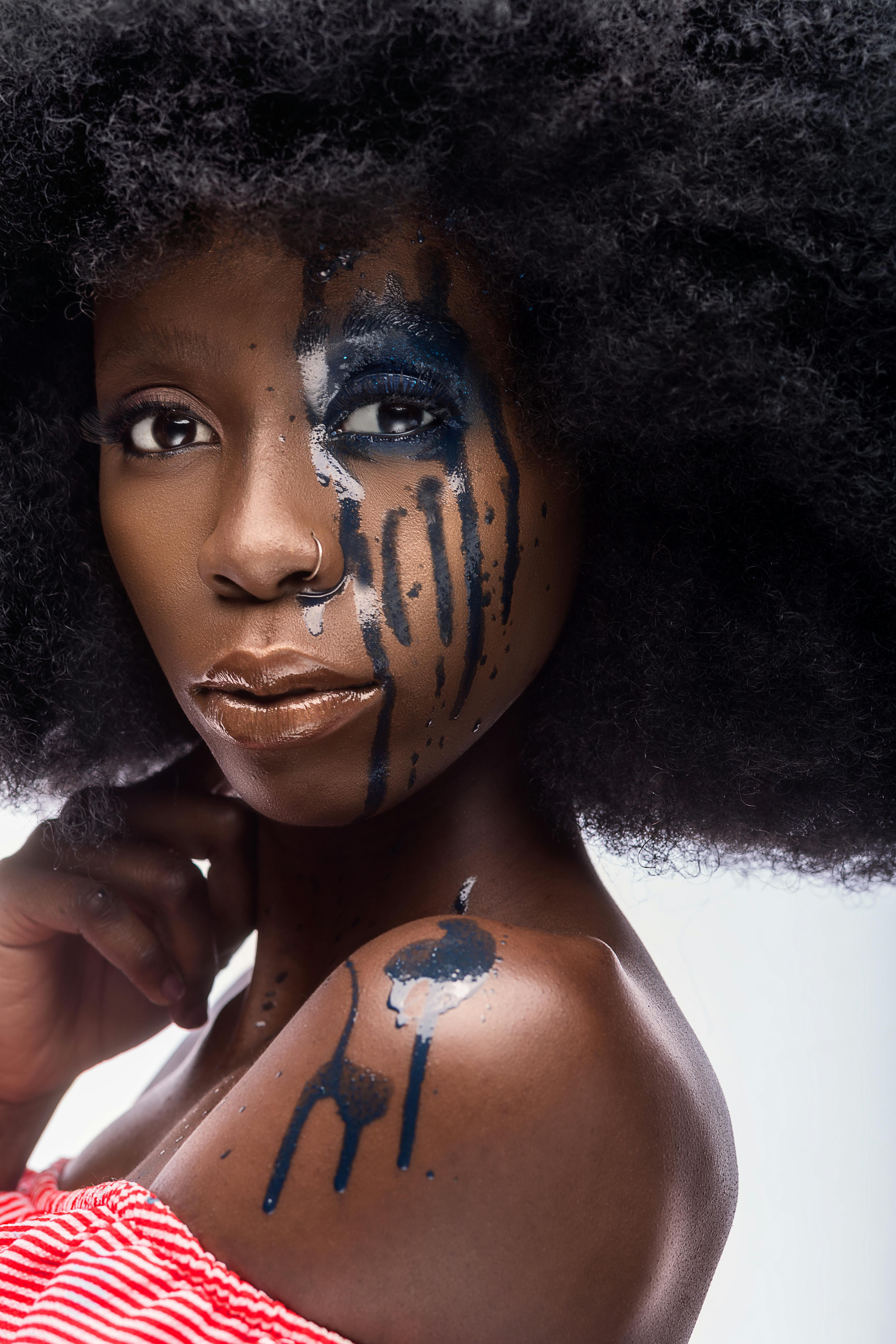 Young Brunette Woman with Face Paint on her Forehead · Free Stock Photo