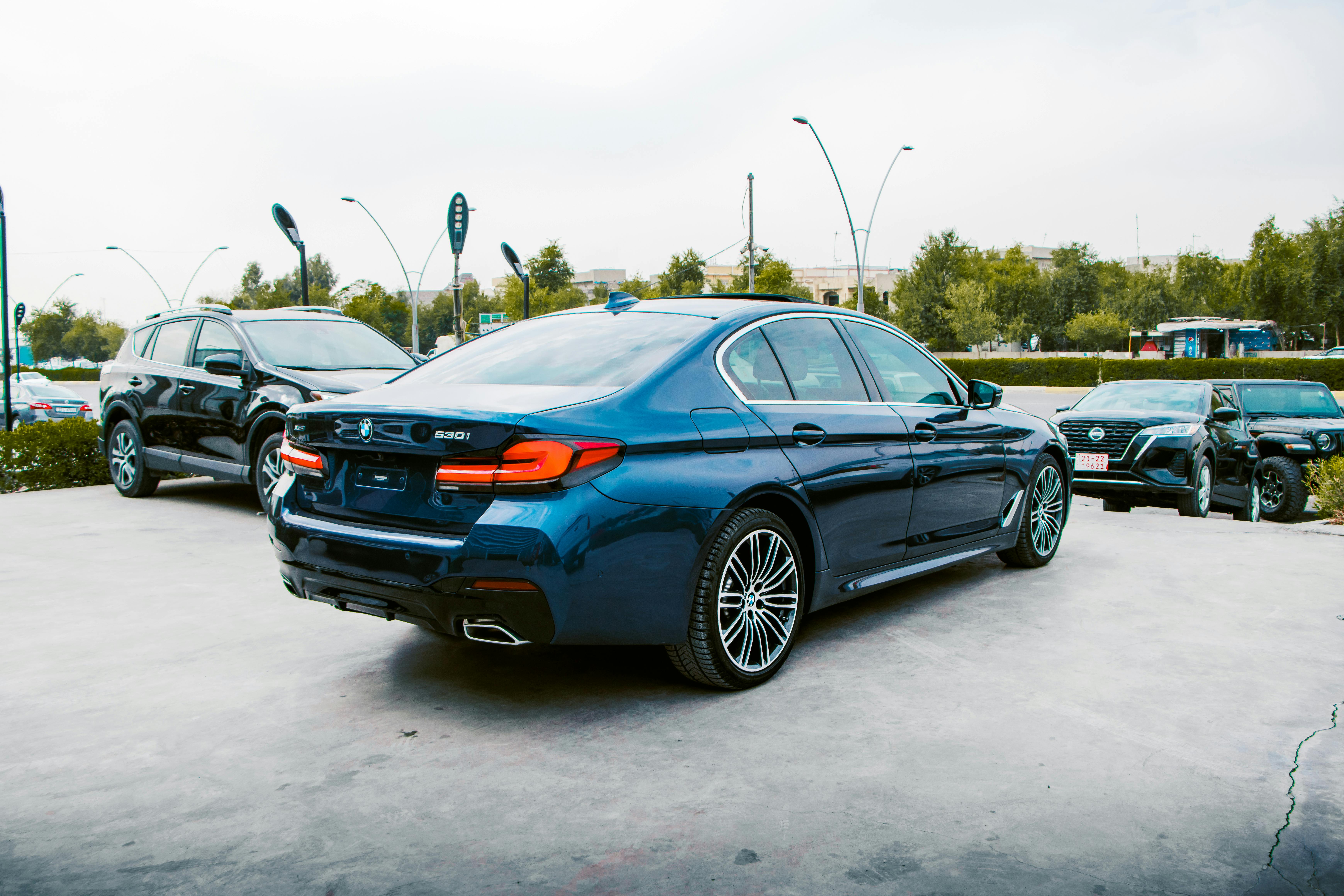 Blue BMW S30i Parked Near Cars · Free Stock Photo