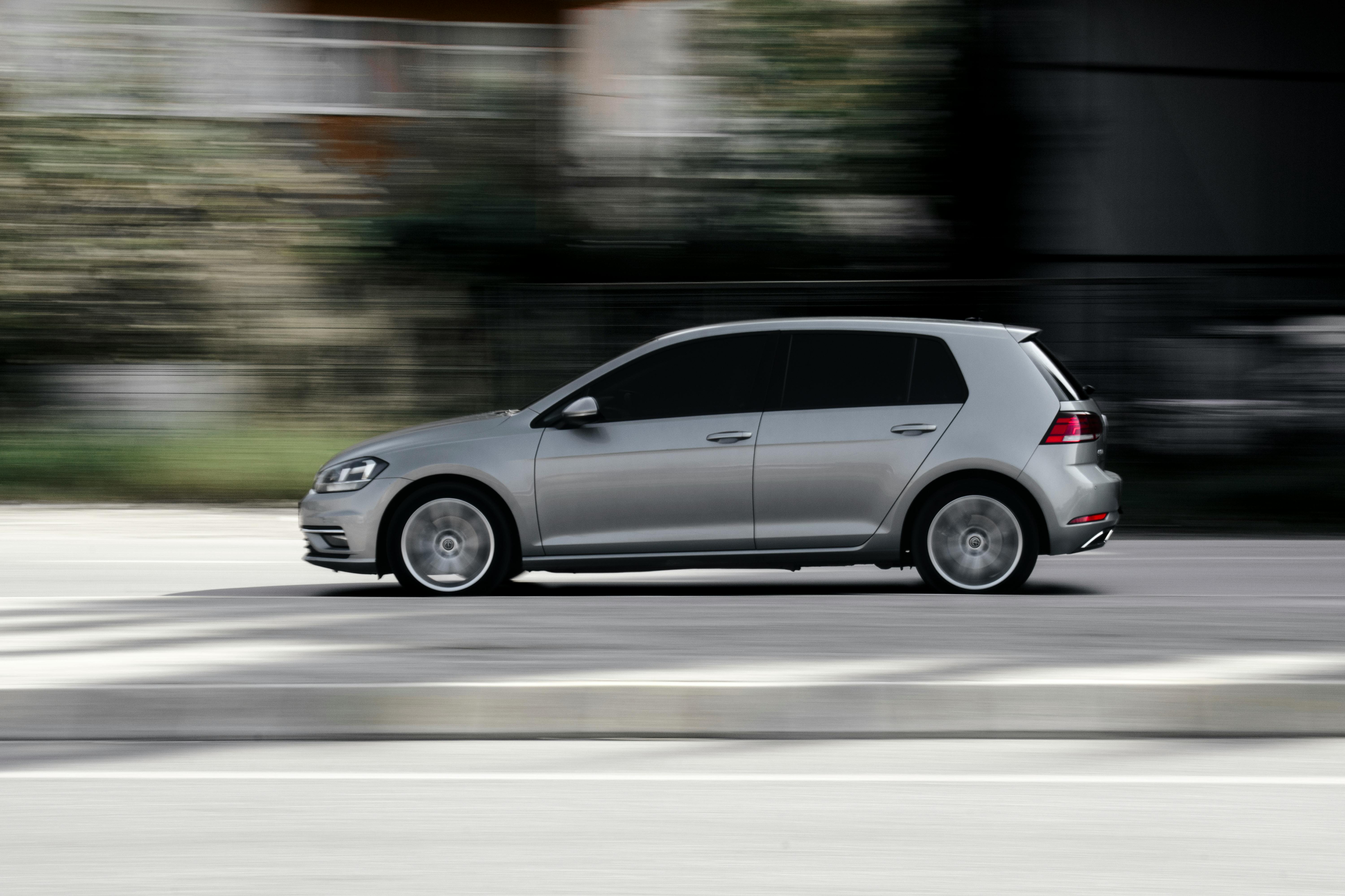 Silver Hatchback Driving Fast on the Road · Free Stock Photo