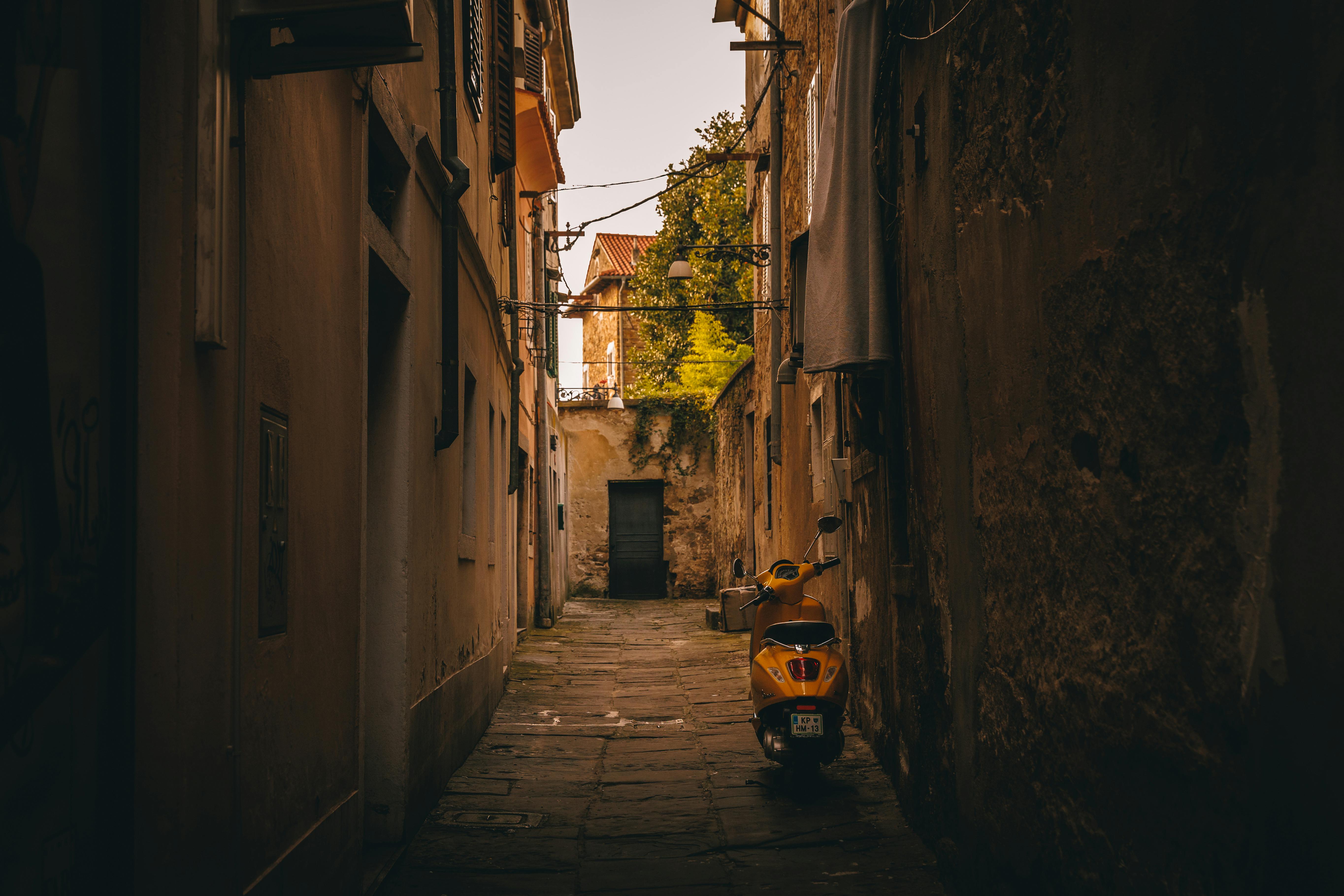 A Narrow Alley between Traditional Buildings with Wooden Shutters ...