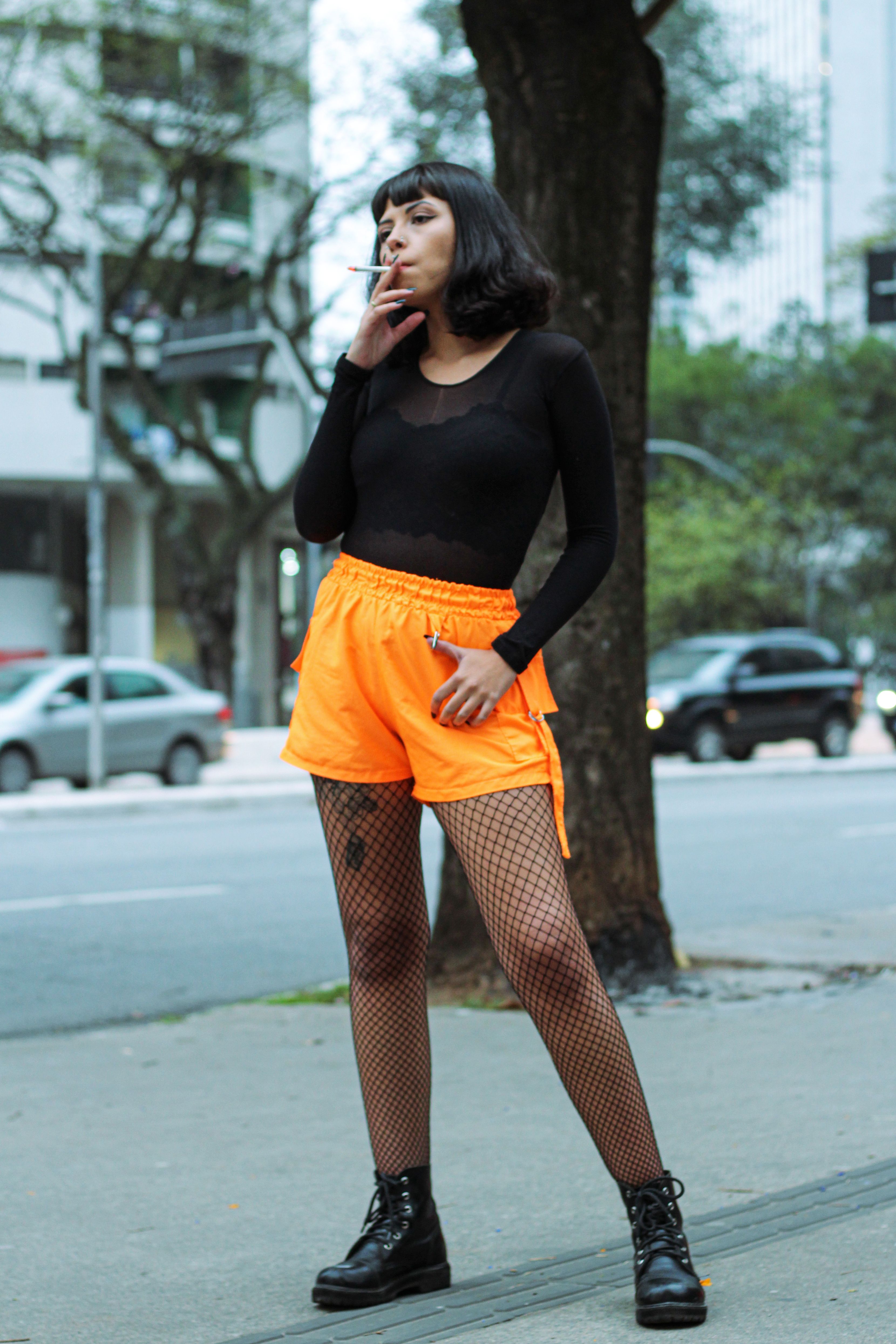 A Woman Smoking Cigarette on the Sidewalk · Free Stock Photo
