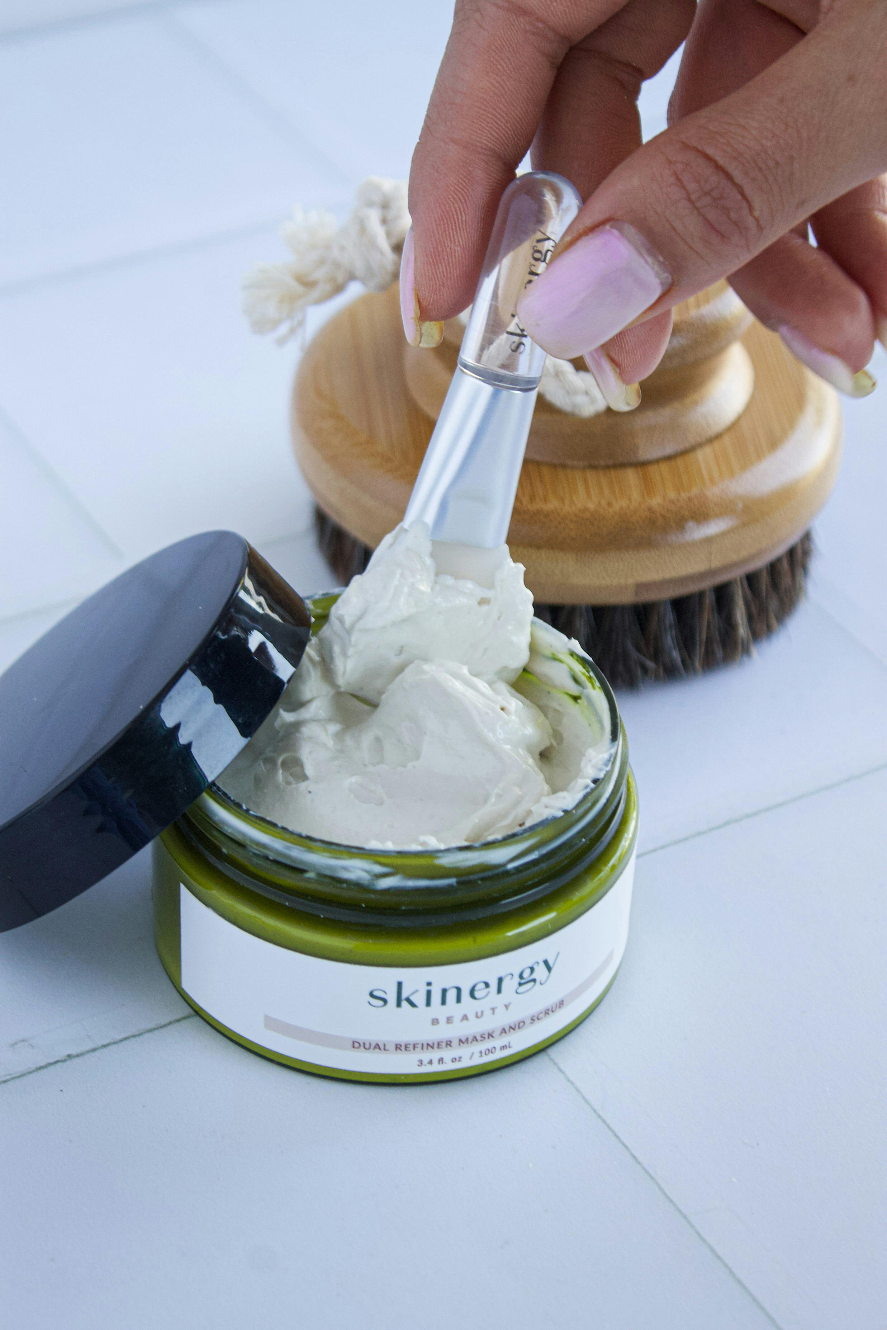 Woman Scooping out Face Mask from a Container · Free Stock Photo
