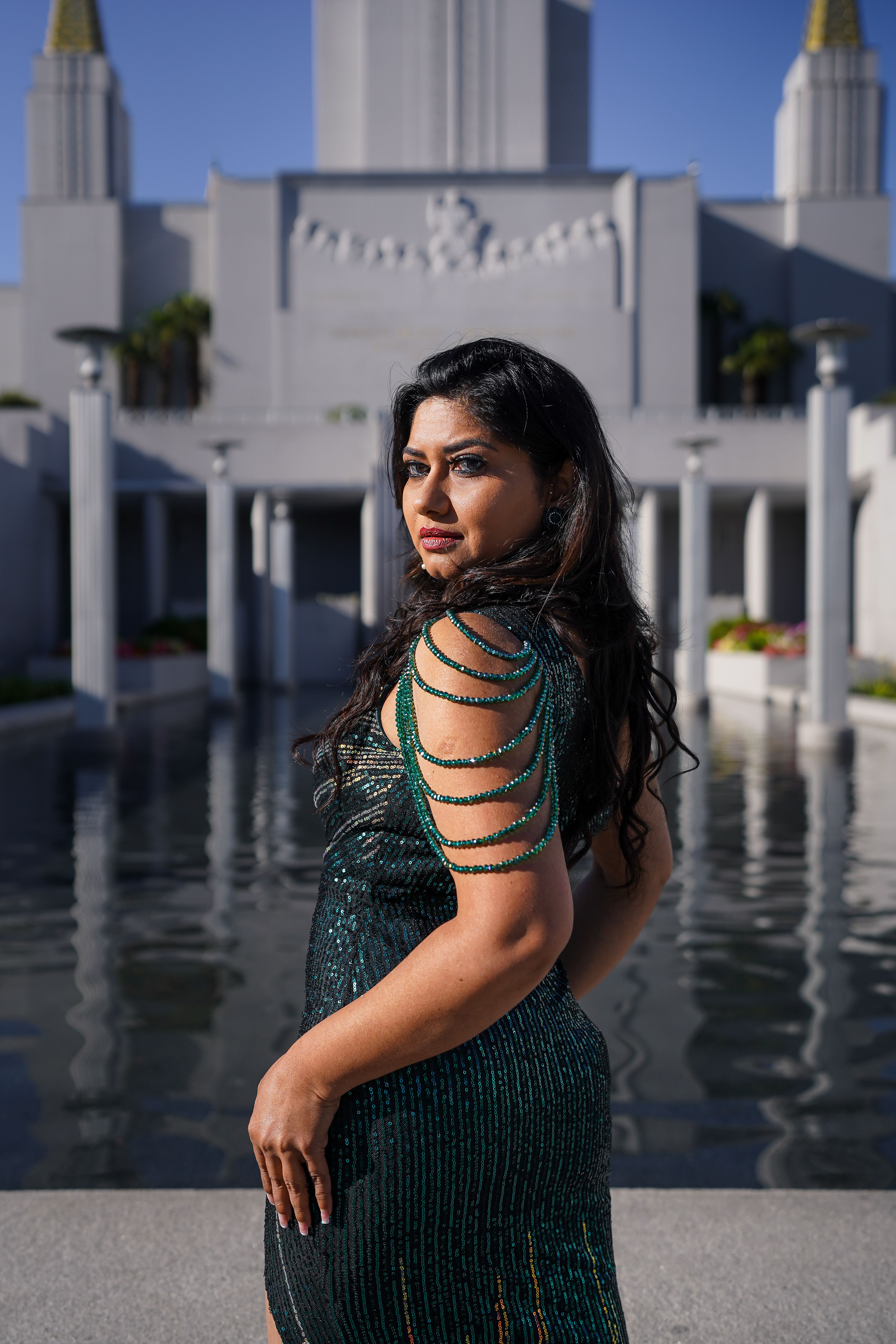 Woman Posing near Pond in front of Building · Free Stock Photo