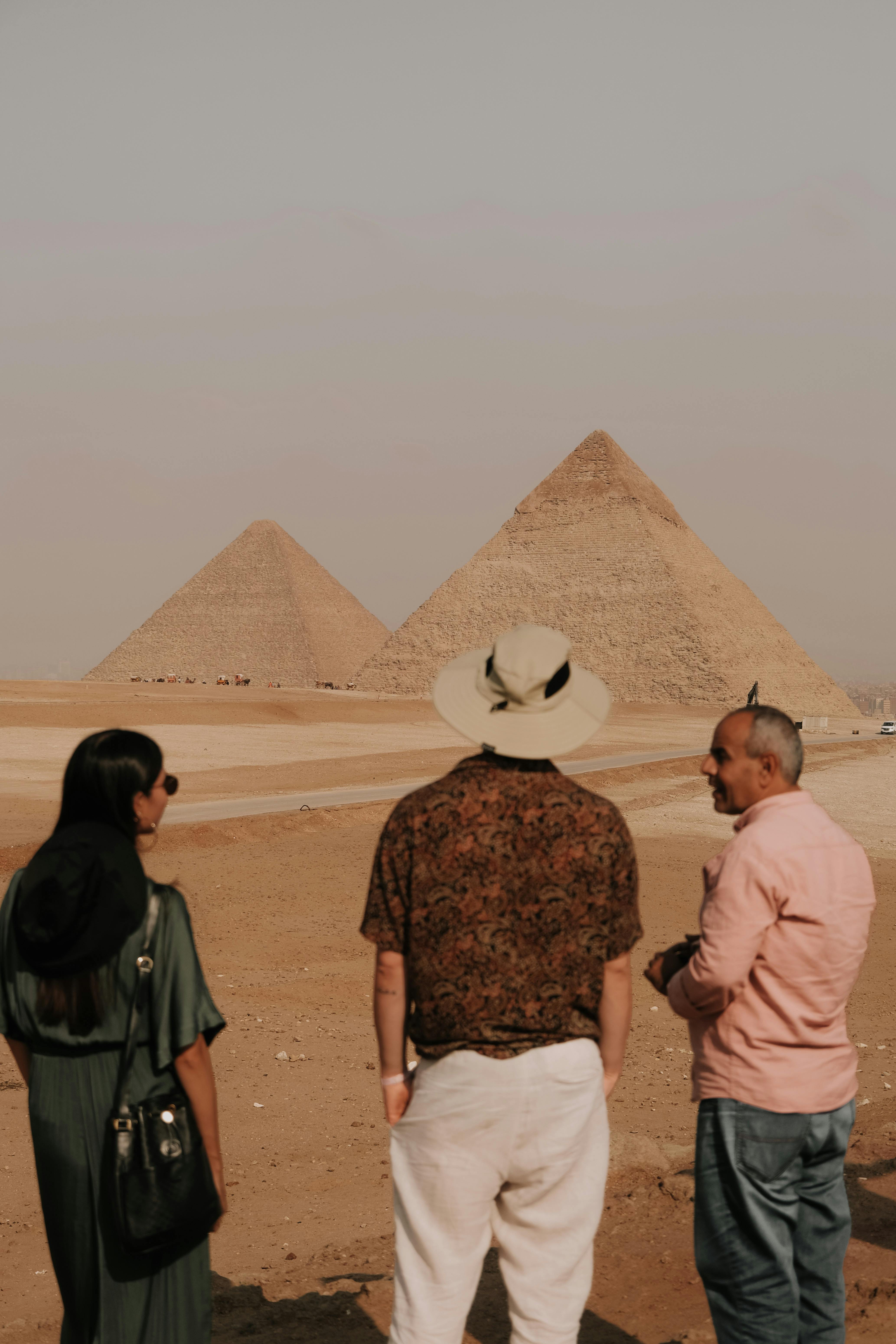 Tourists Admiring Egyptian Pyramids While Talking With a Local Man ...