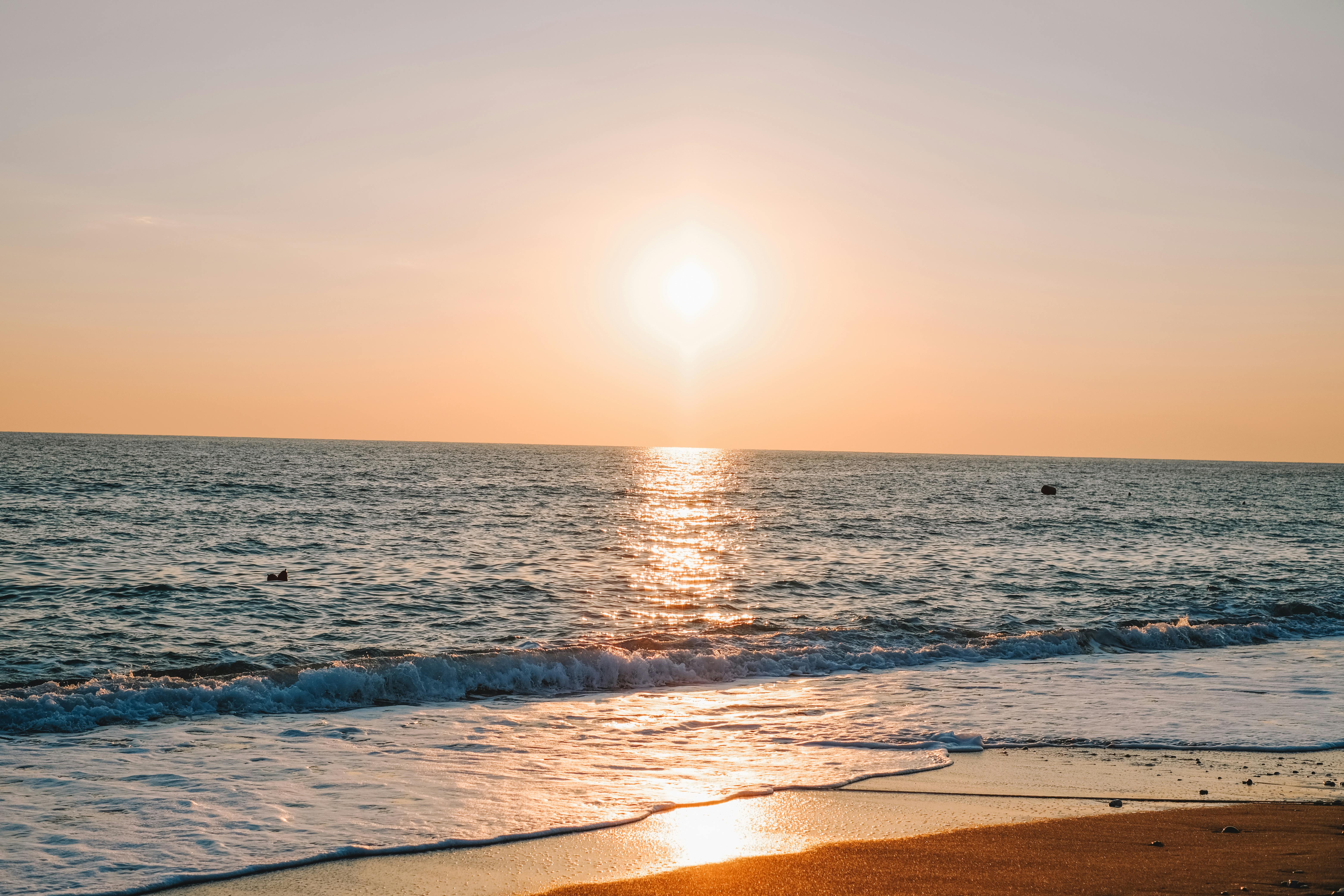 A Sun Setting Over the Ocean · Free Stock Photo